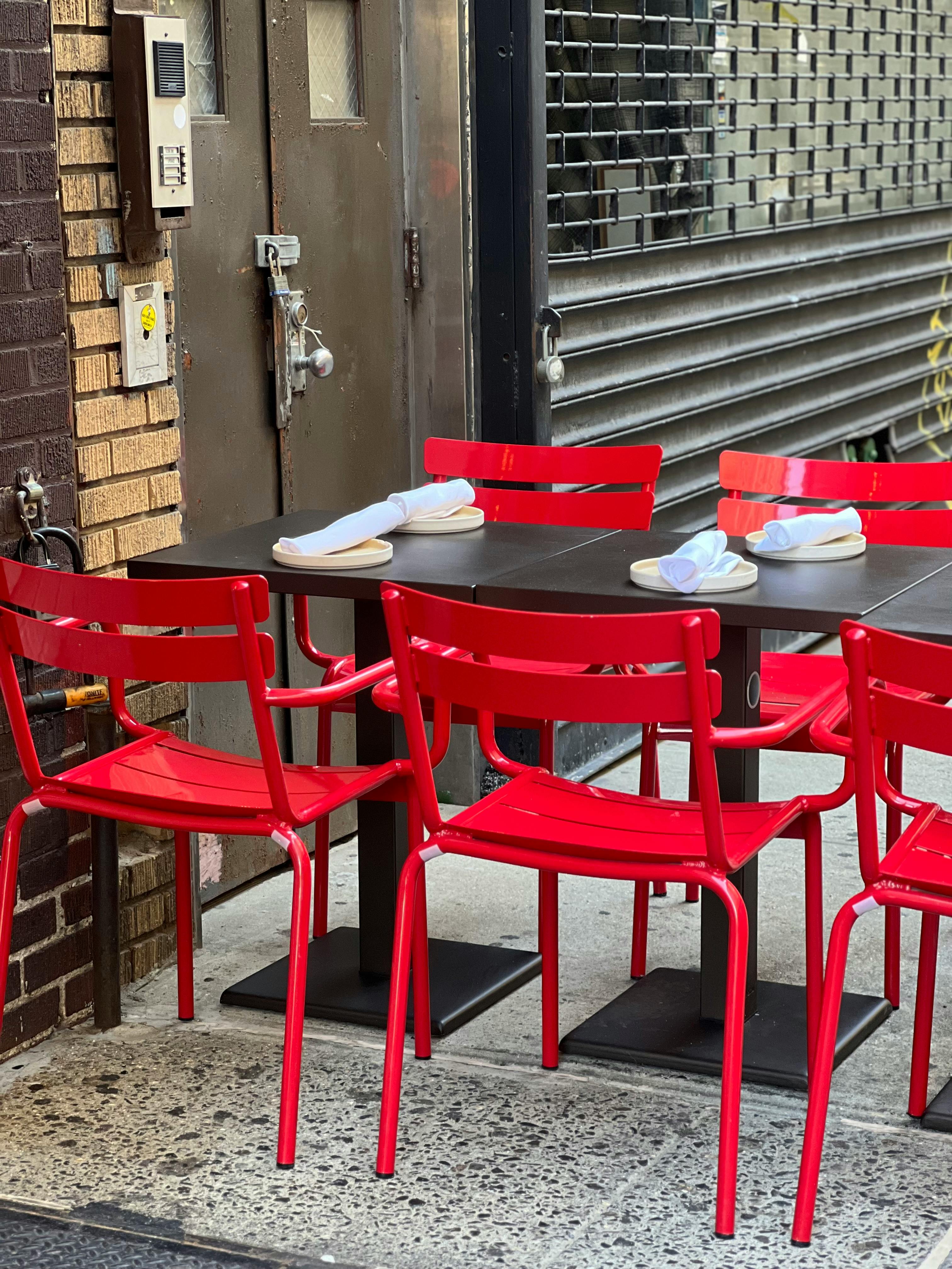 Outdoor Cafe Setting with Red Chairs · Free Stock Photo