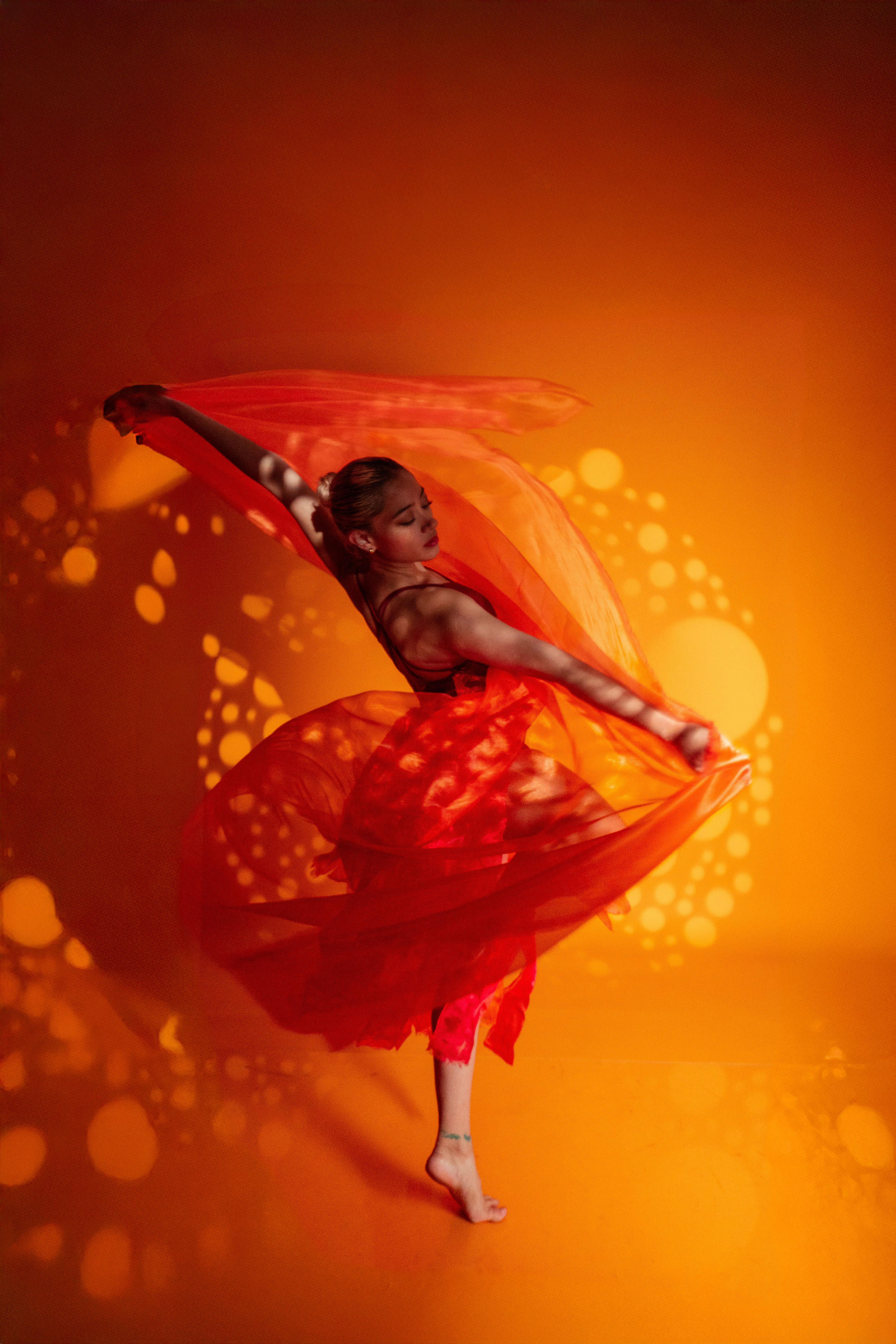 Elegant Ballet Dancer in Orange Flowing Dress · Free Stock Photo