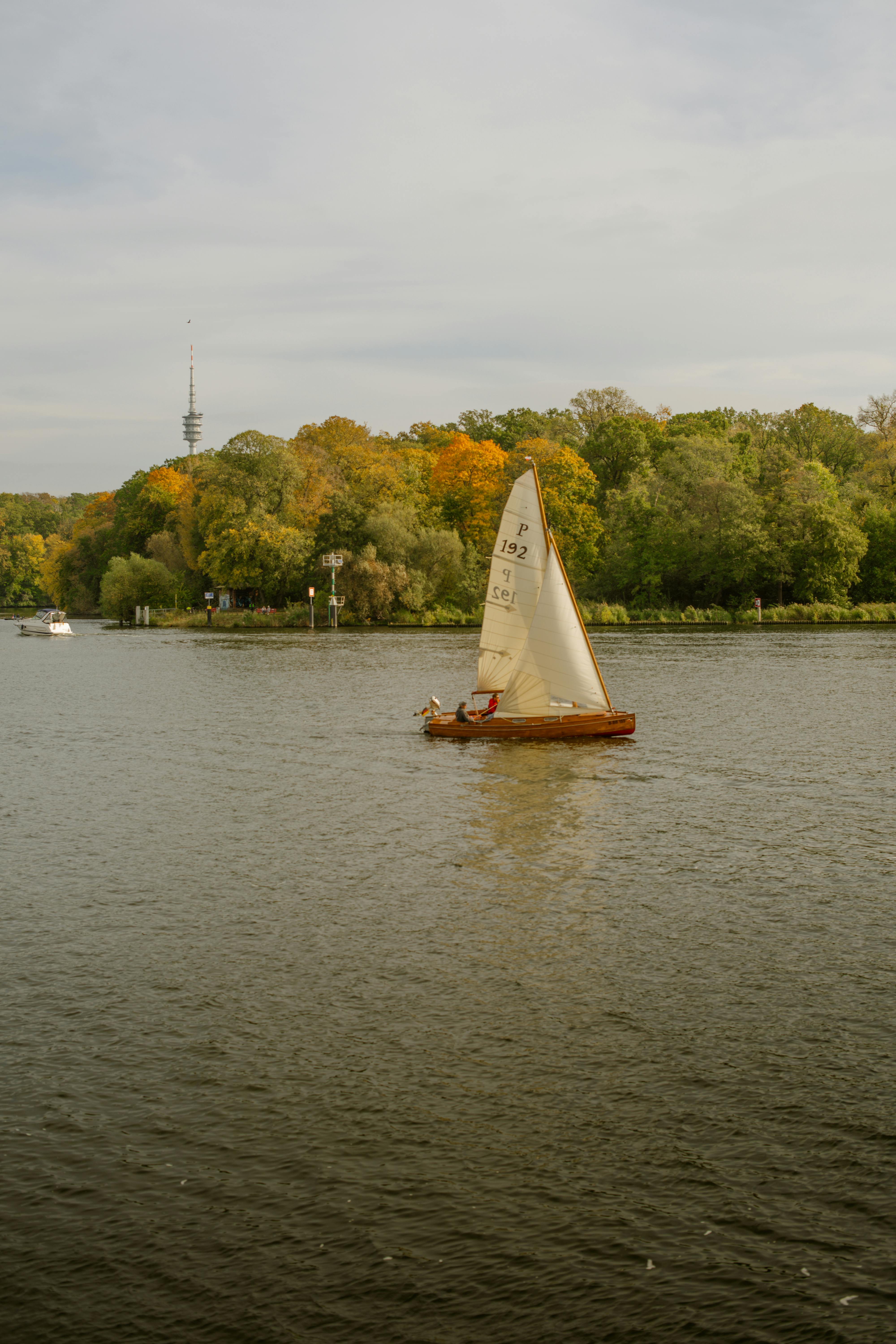 Sailboat on a Tranquil Lake in Autumn · Free Stock Photo