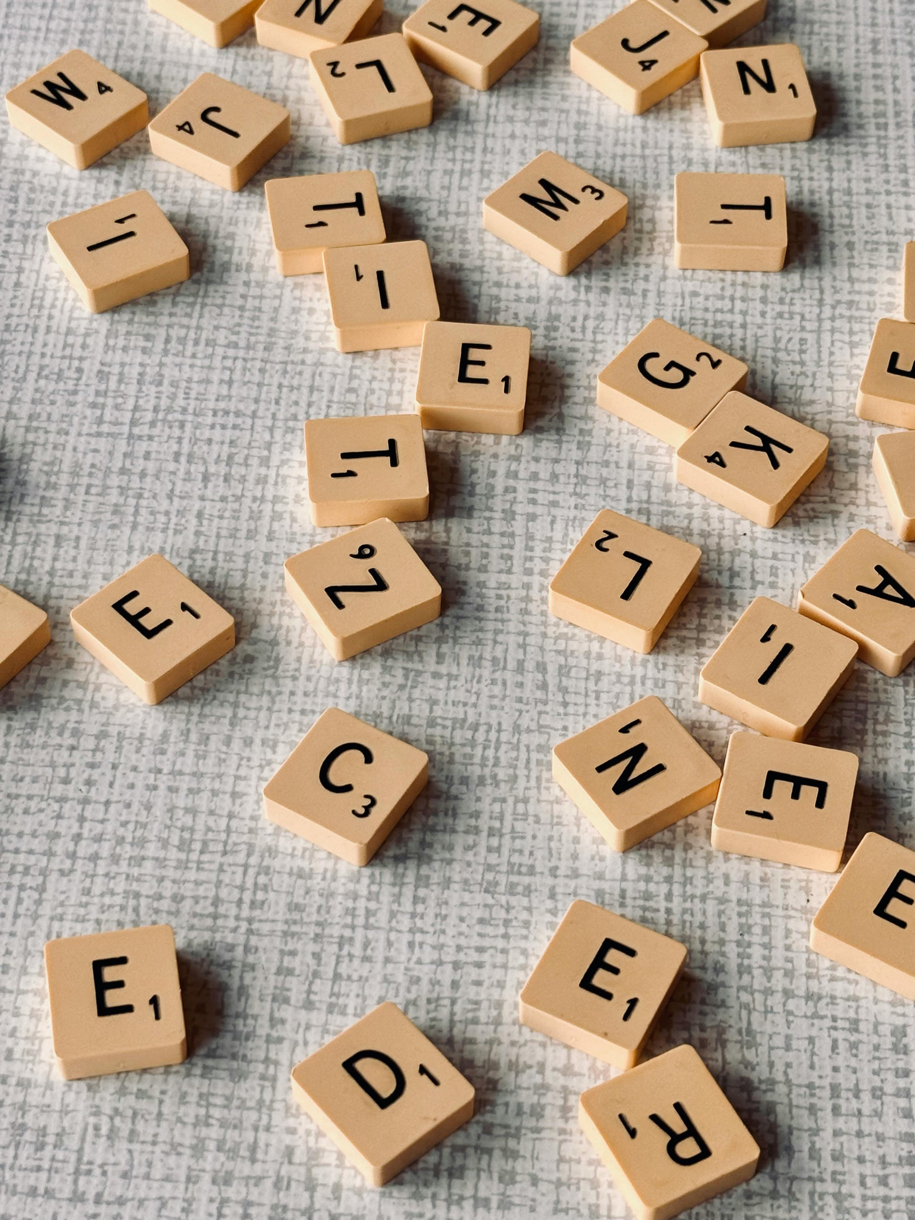 Close-up of Scrabble Tiles on a Textured Surface · Free Stock Photo