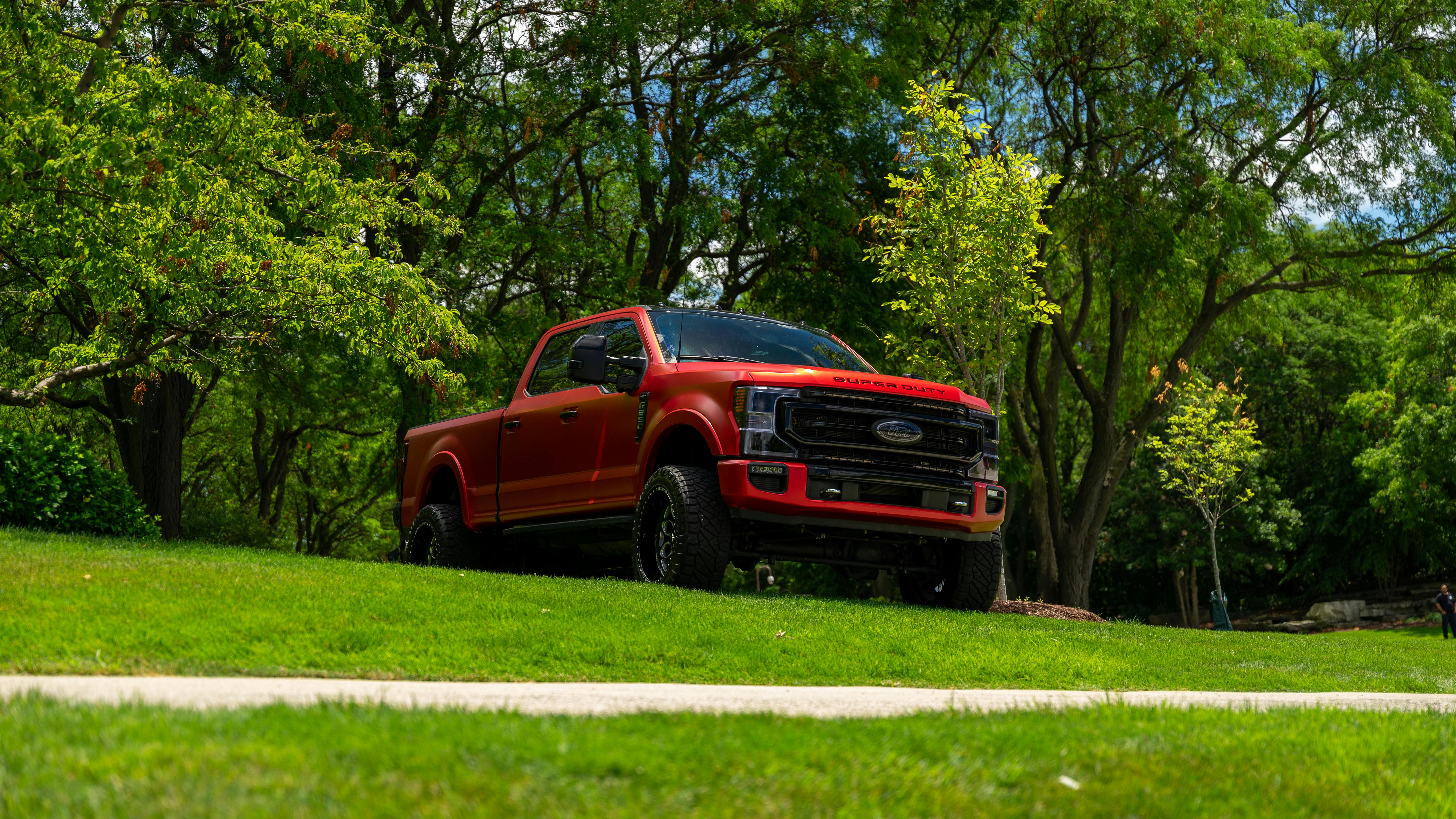 Red RAM Truck with Black Rims in Industrial Setting · Free Stock Photo
