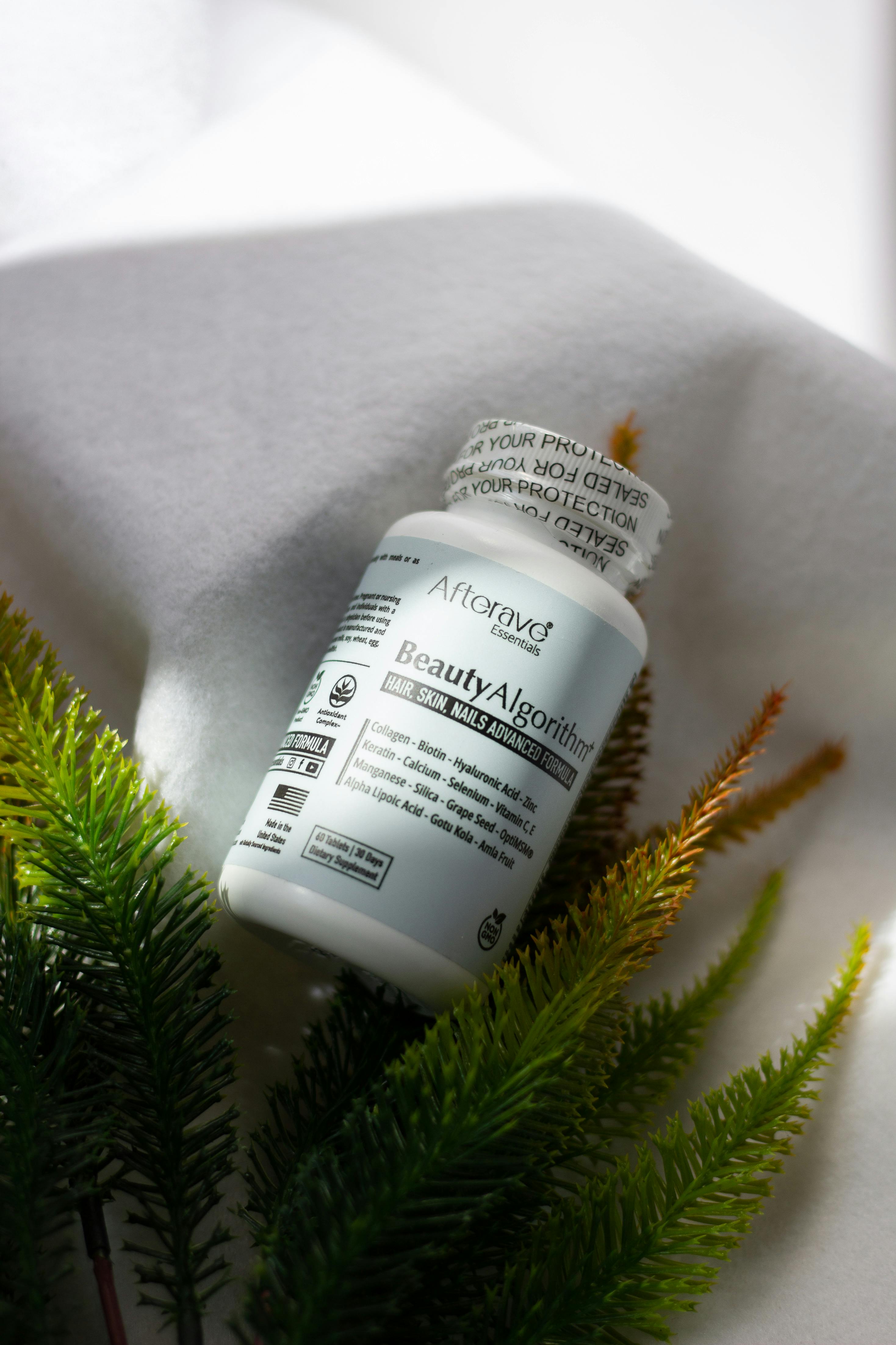 Beauty Supplement Bottle Amidst Greenery · Free Stock Photo