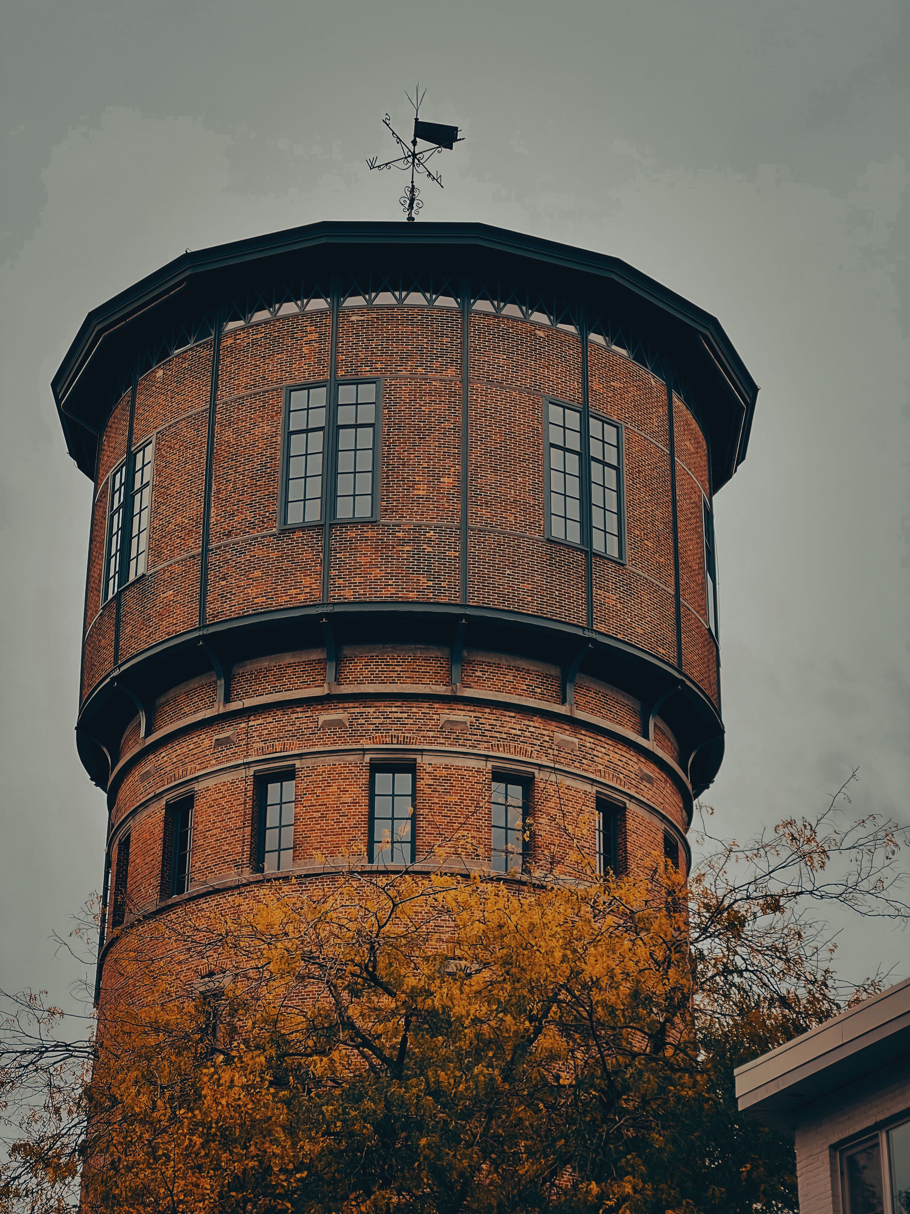 Historic Brick Water Tower in Autumn Setting · Free Stock Photo