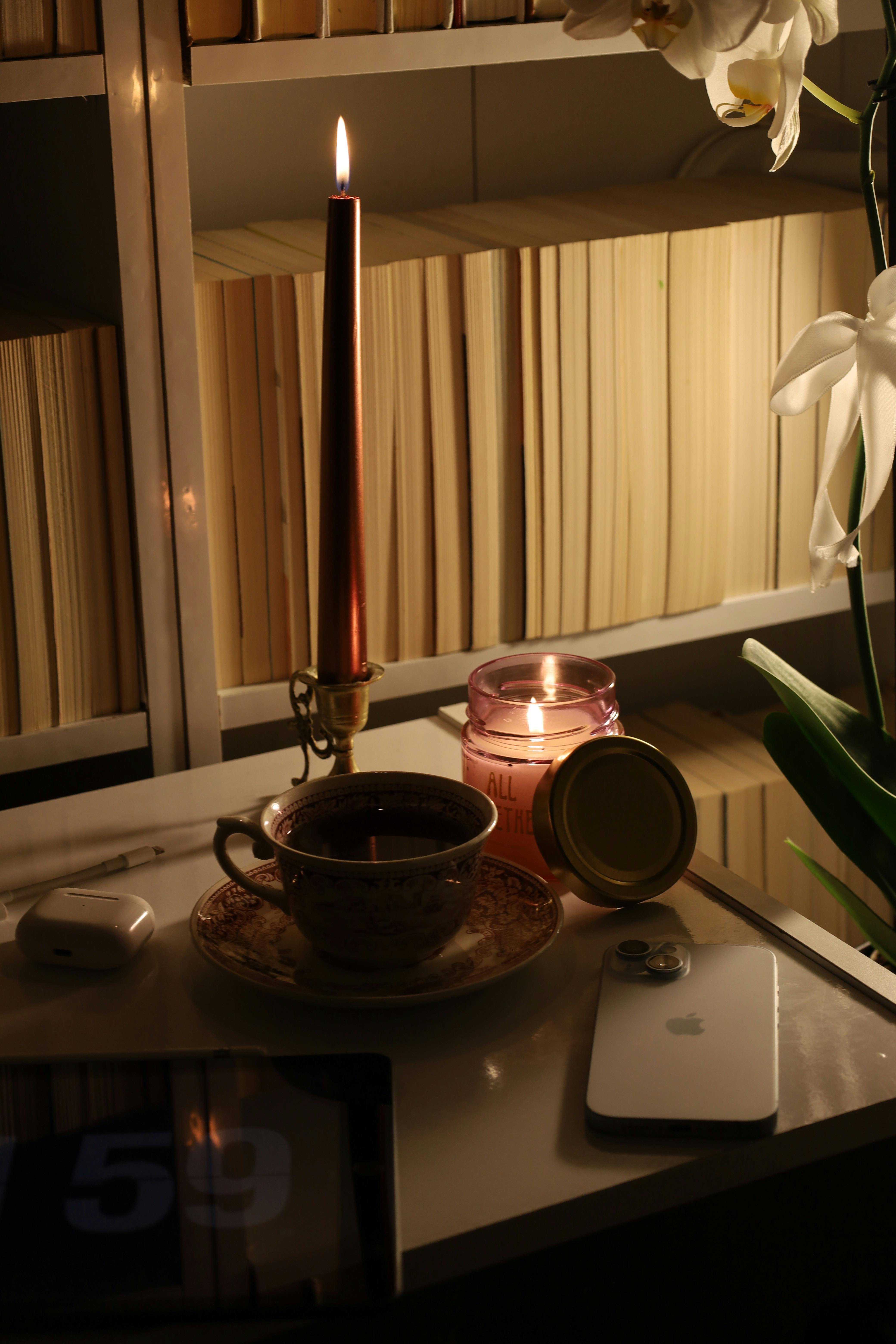 Open Book among Scented Candles · Free Stock Photo