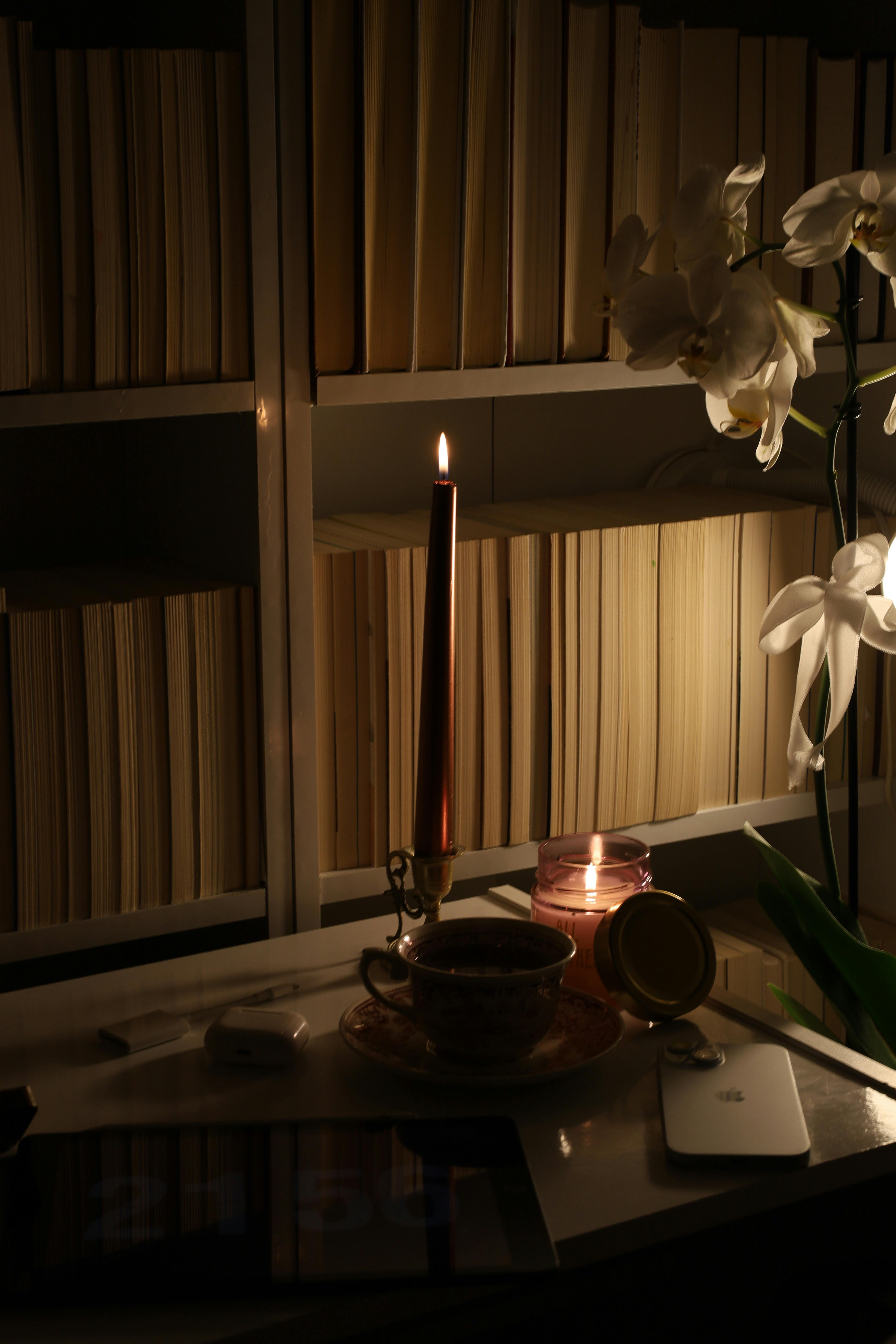 Cozy Candlelit Evening With Books and Tea · Free Stock Photo