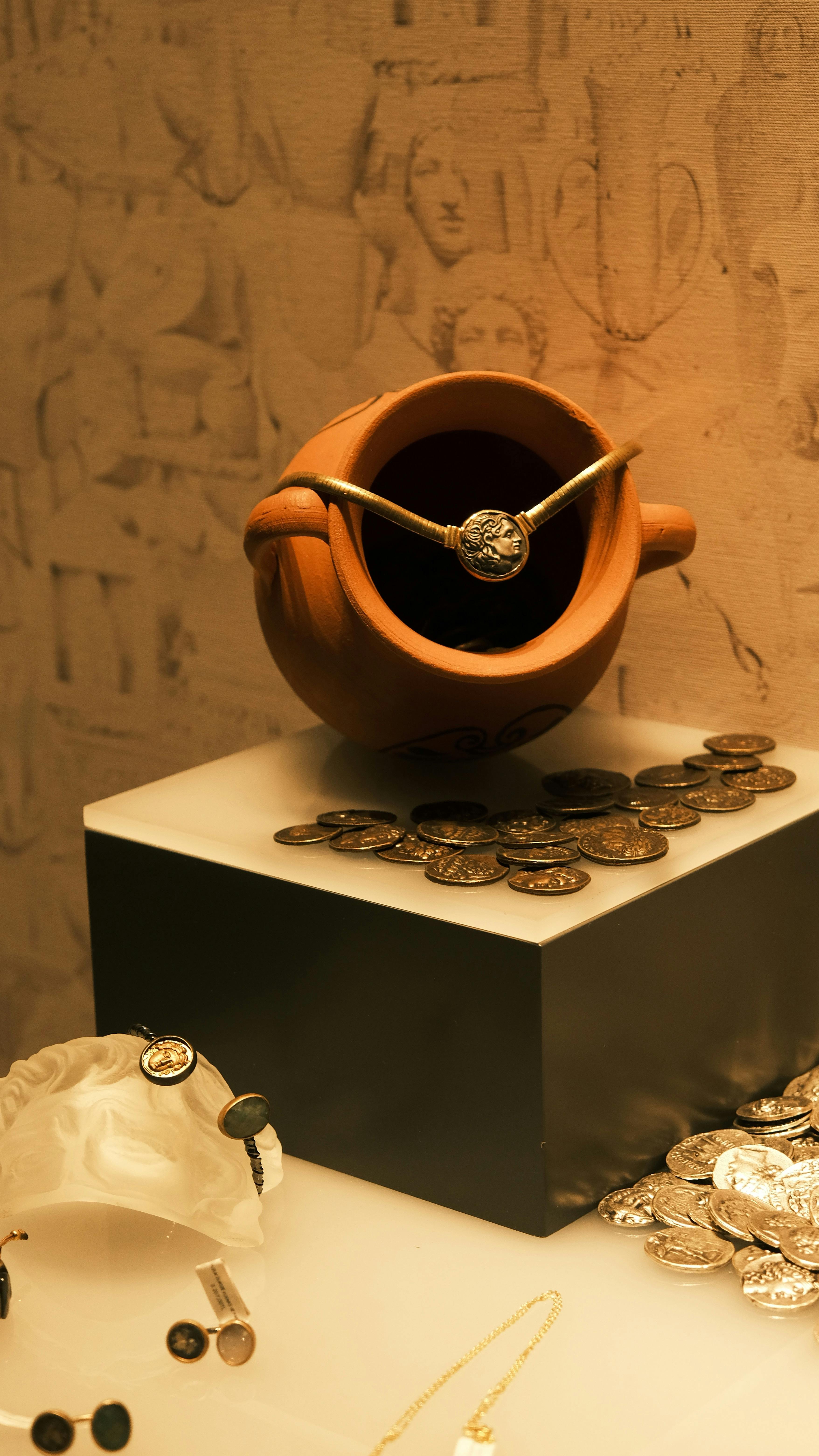 Ancient Coins in a Ceramic Vase Display · Free Stock Photo