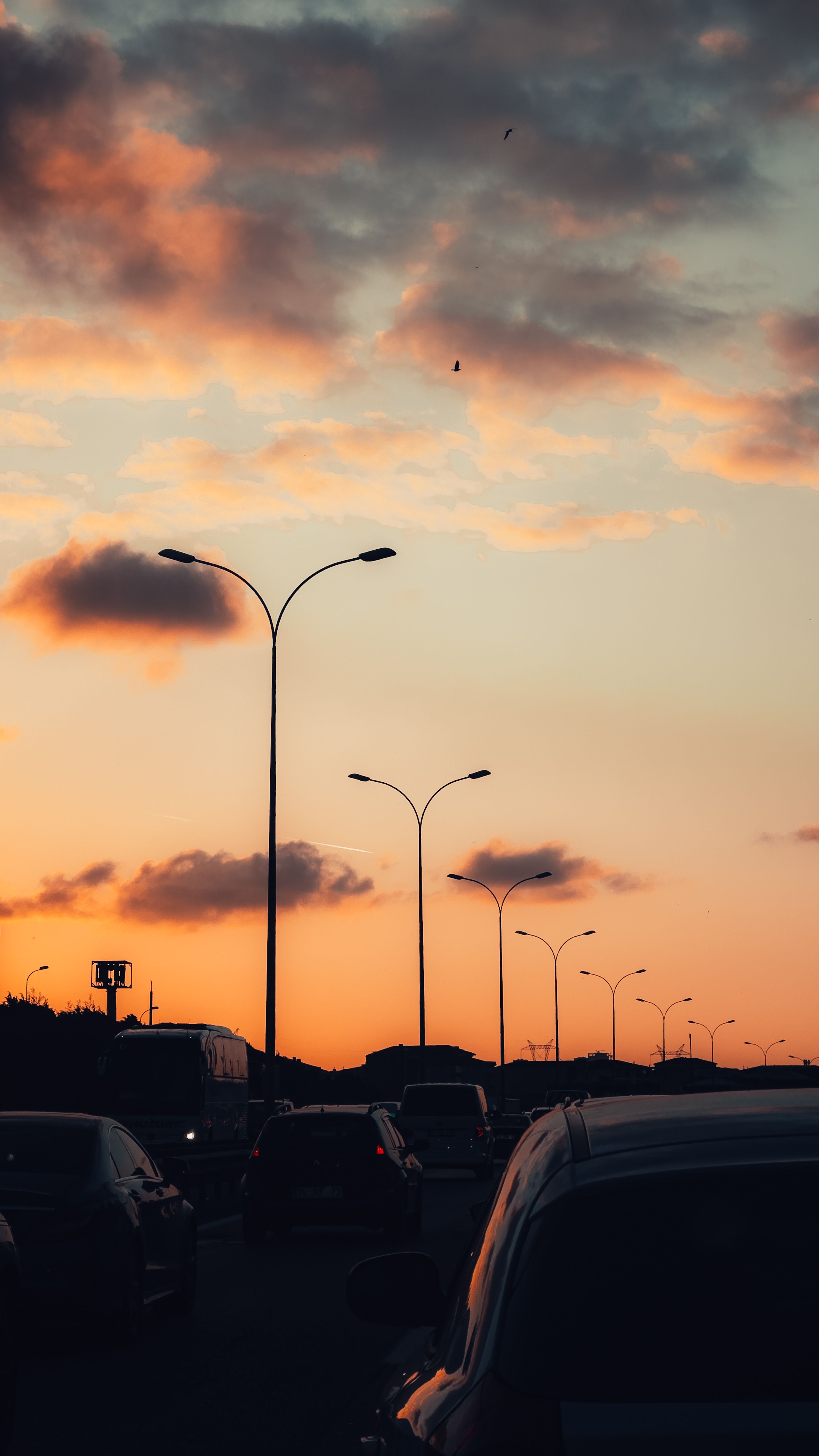 Urban Traffic Against a Vibrant Sunset Sky · Free Stock Photo