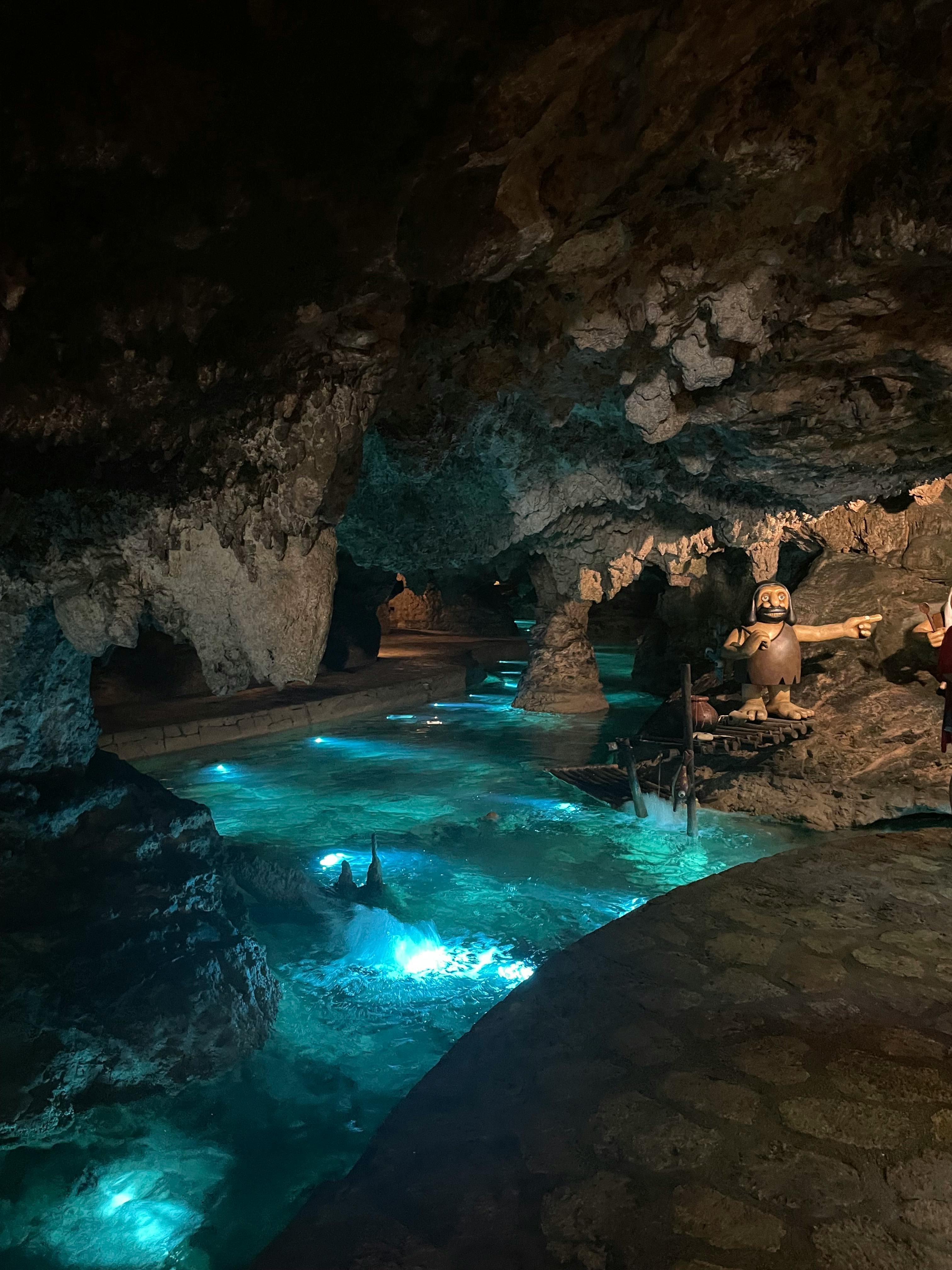 A Man Standing in the Middle of the Cave Surrounded with Water · Free ...