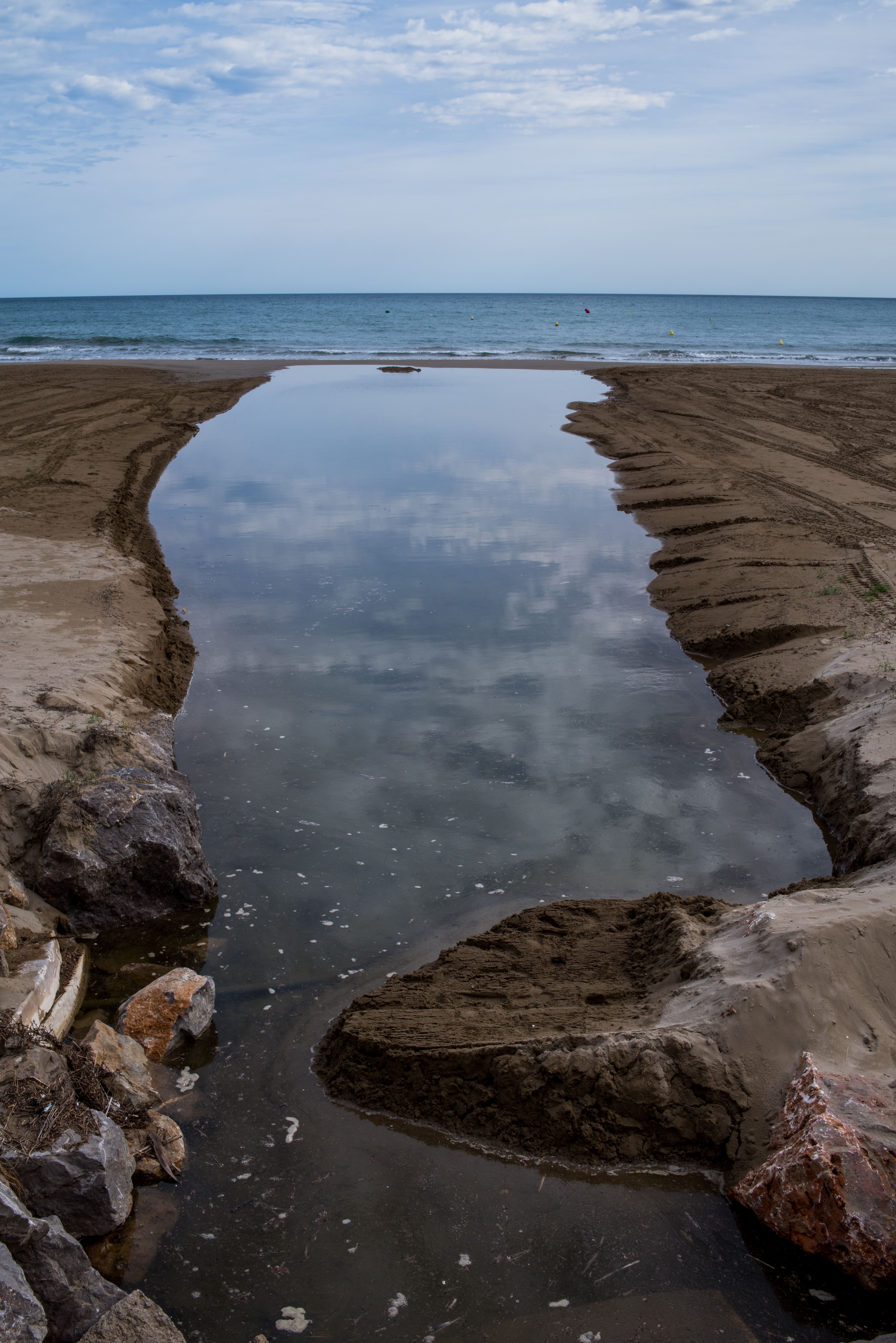 Coastal View with Reflective Water and Sandy Beach · Free Stock Photo