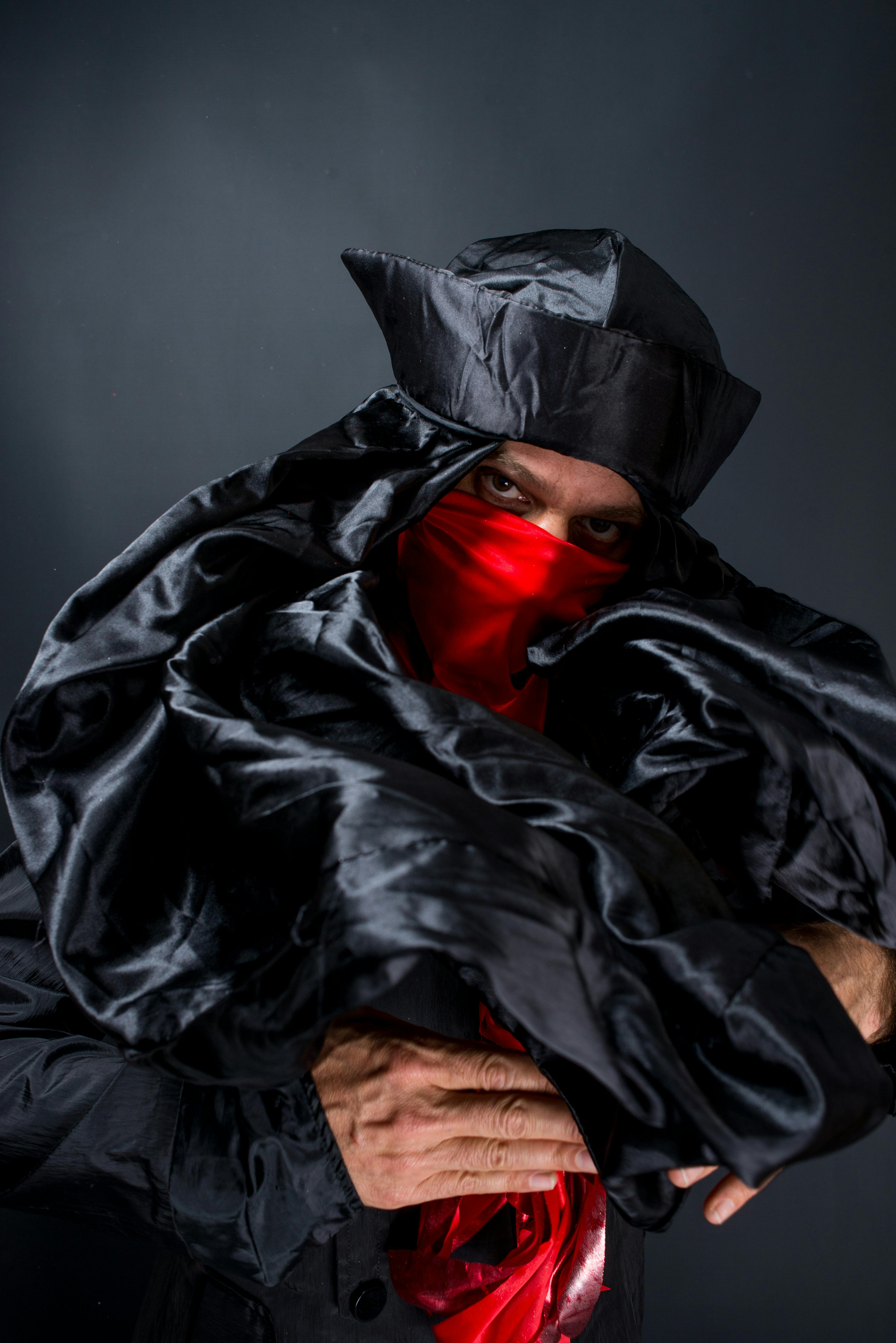 Mysterious Figure in Dark Satin Robes · Free Stock Photo