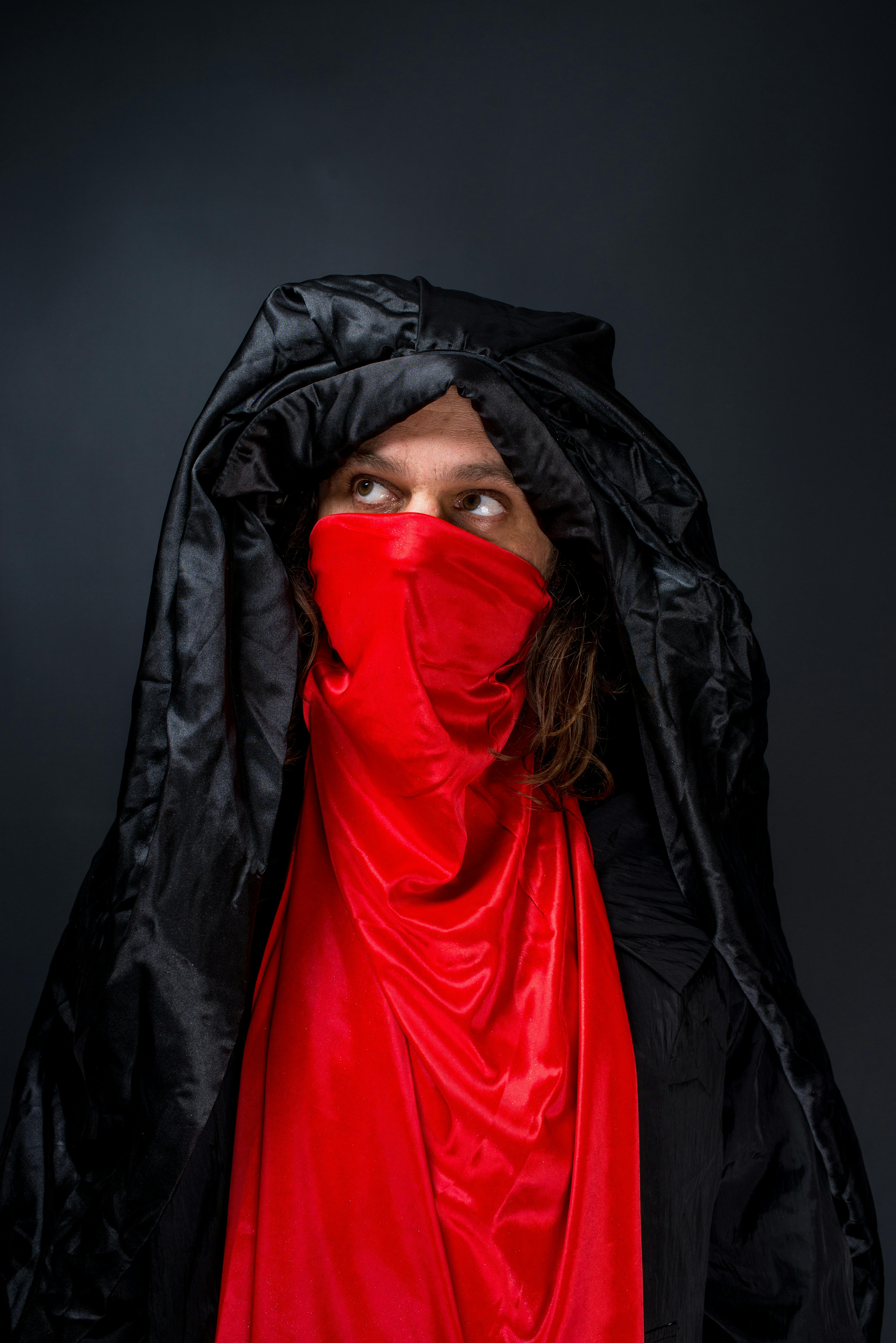 Mysterious Person Draped in Black and Red Cloak · Free Stock Photo