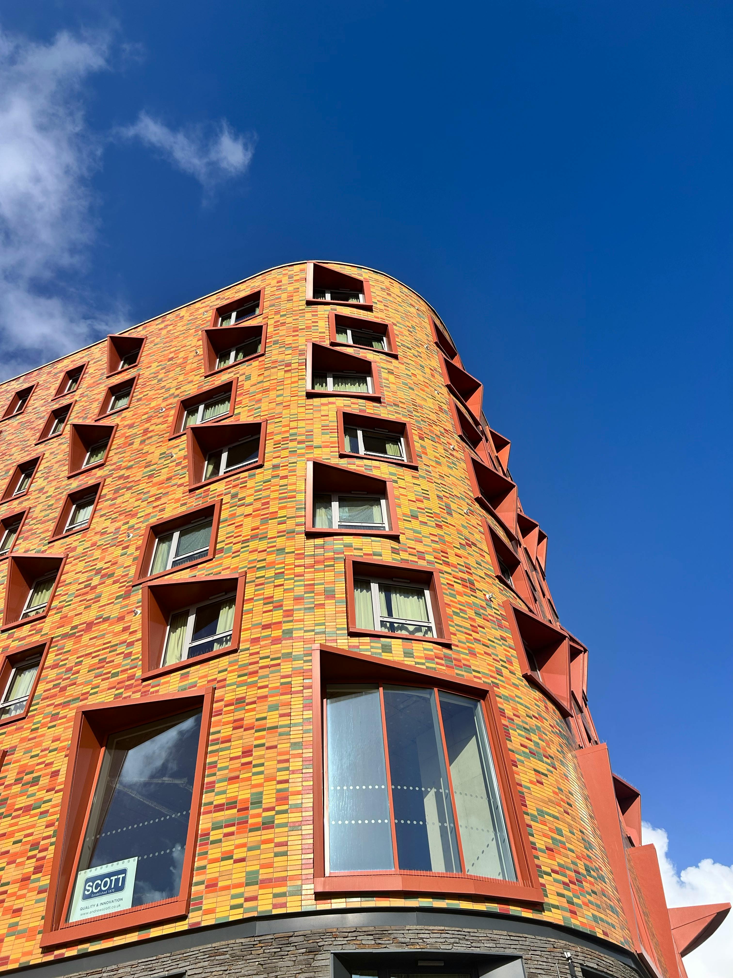 Vibrant Modern Architecture Against Blue Sky · Free Stock Photo