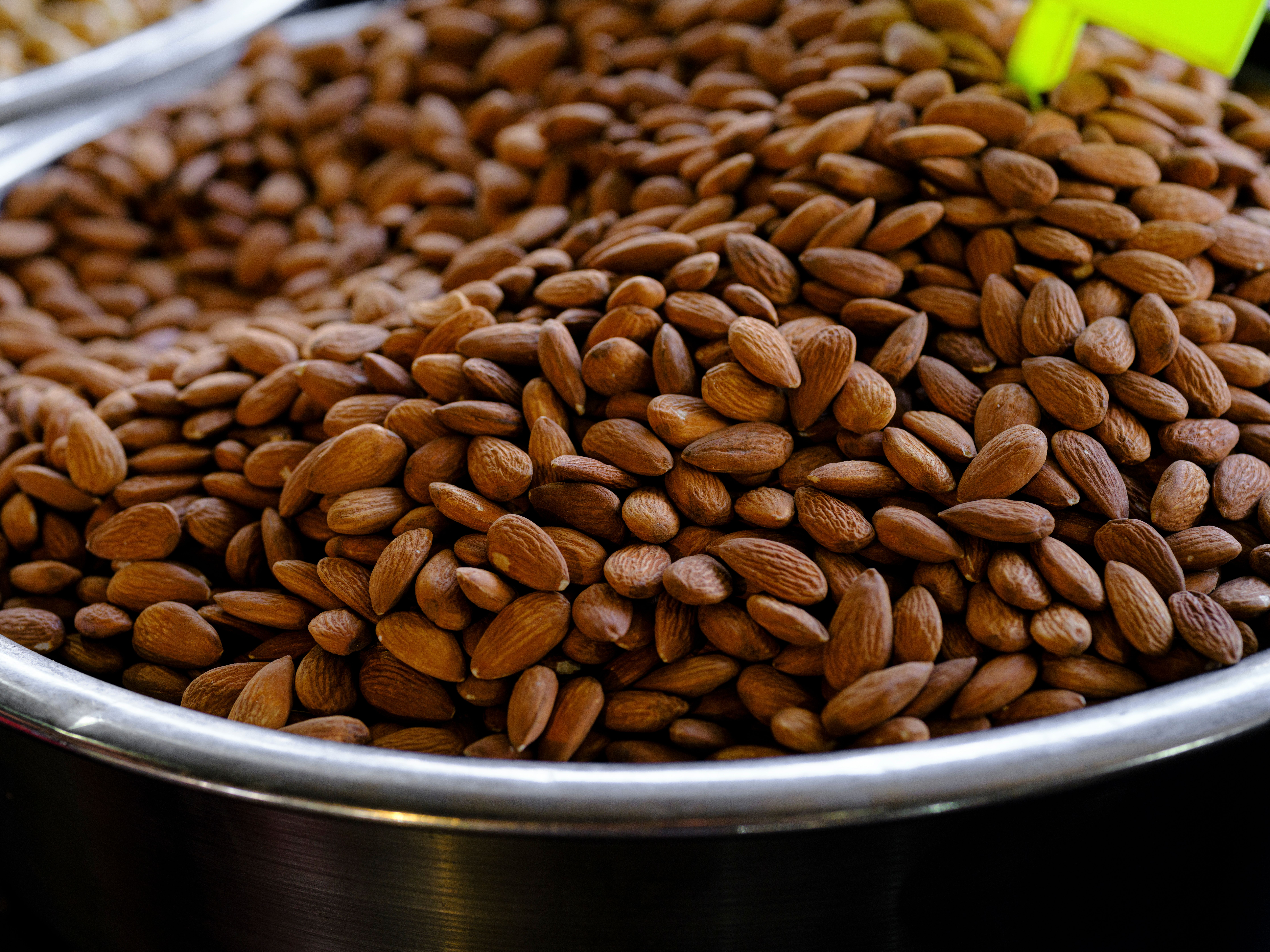Close-Up of Raw Almonds in a Market Bowl · Free Stock Photo