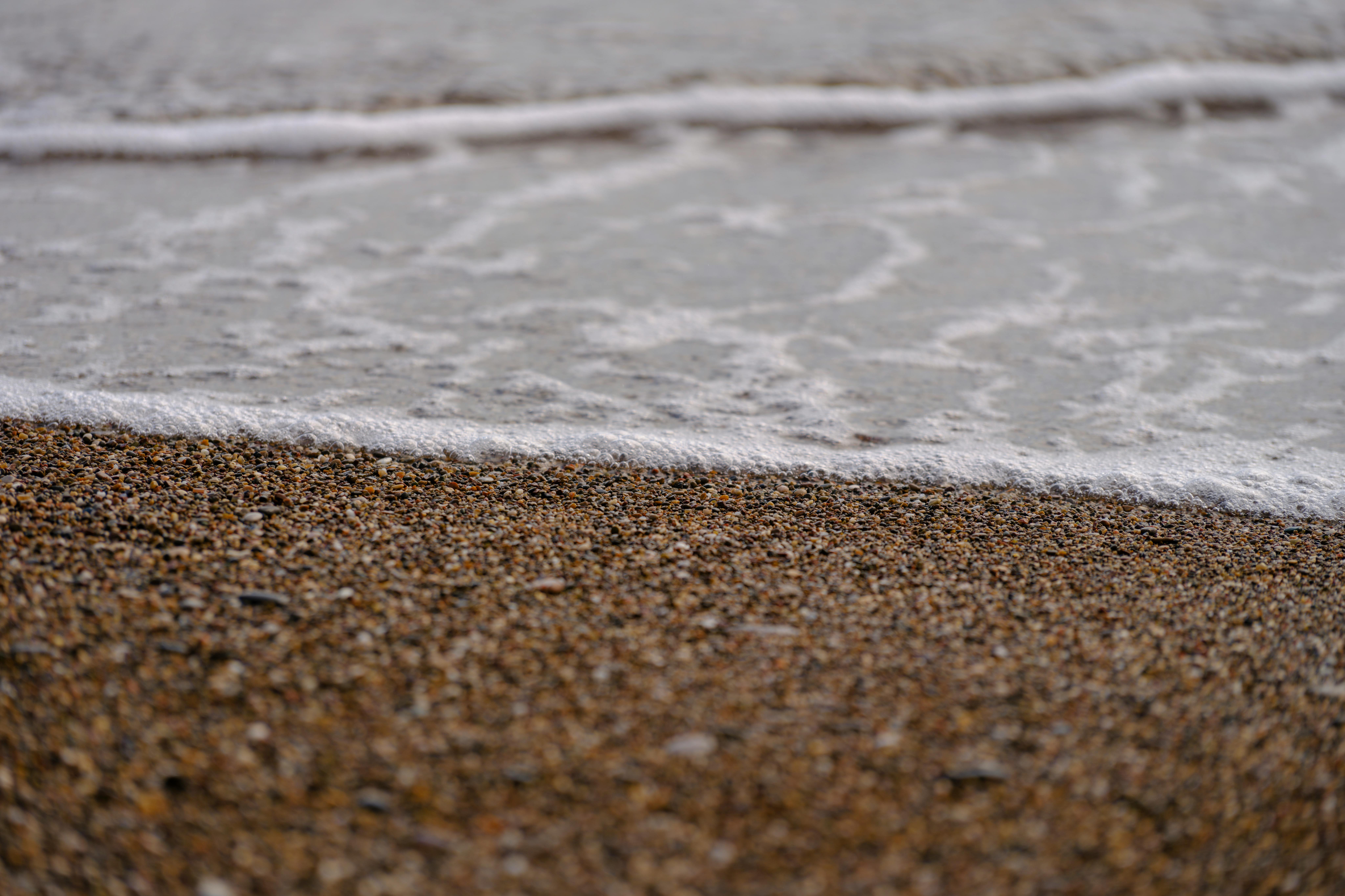 Pebble Beach with Gentle Ocean Waves · Free Stock Photo