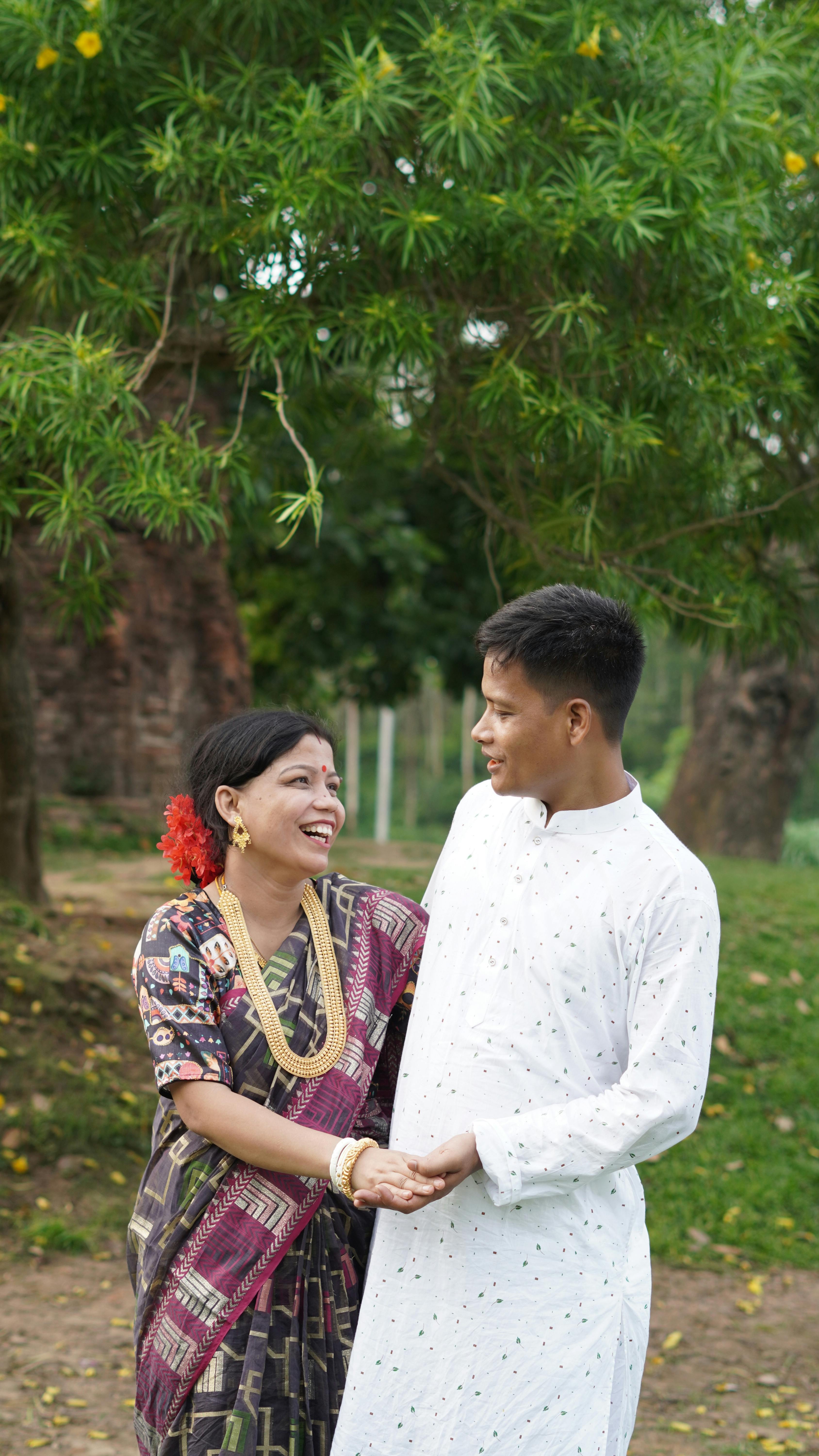 Happy Couple in Traditional Dress Outdoors · Free Stock Photo
