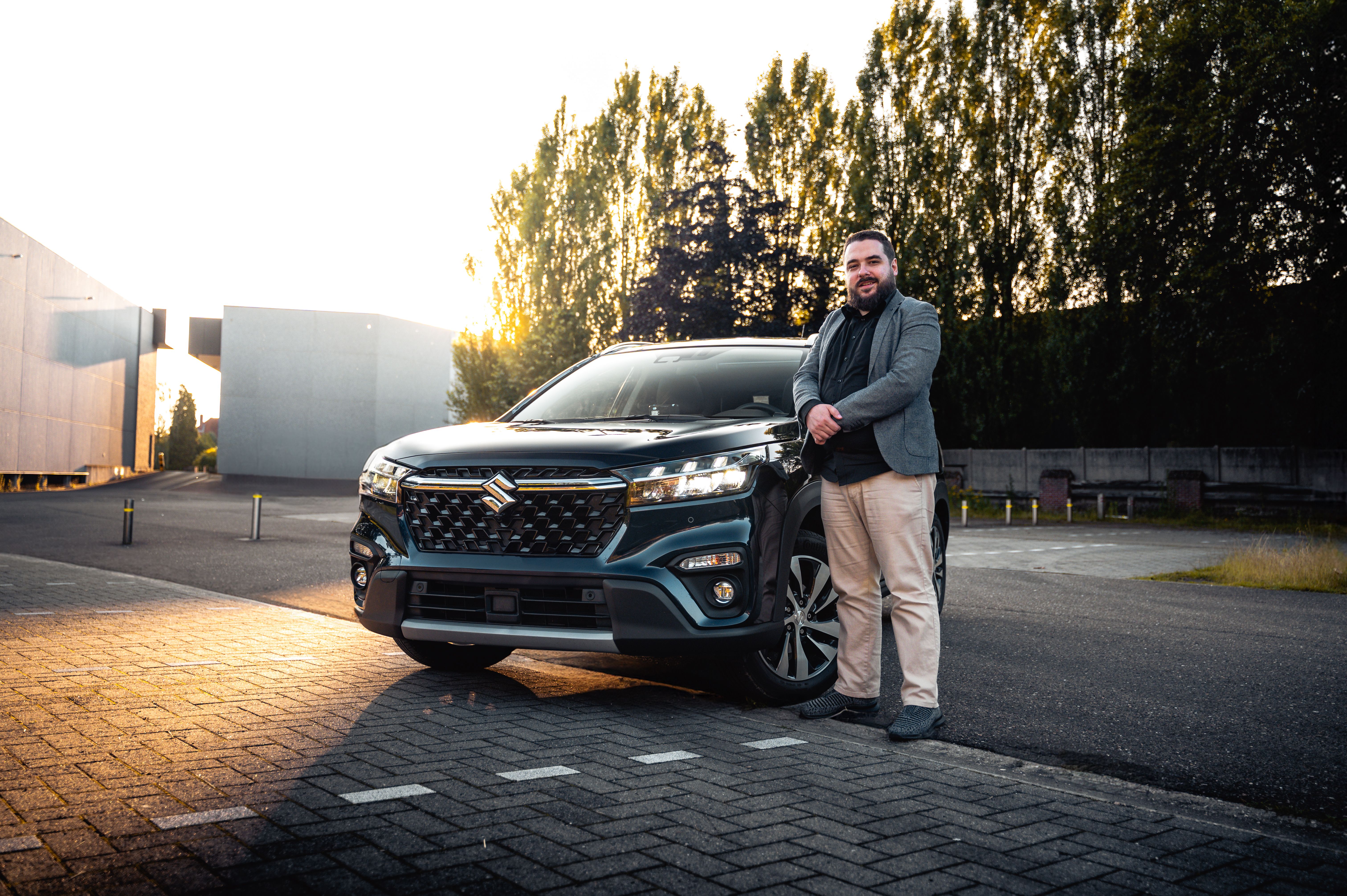 Man Standing Beside Modern SUV at Sunset · Free Stock Photo