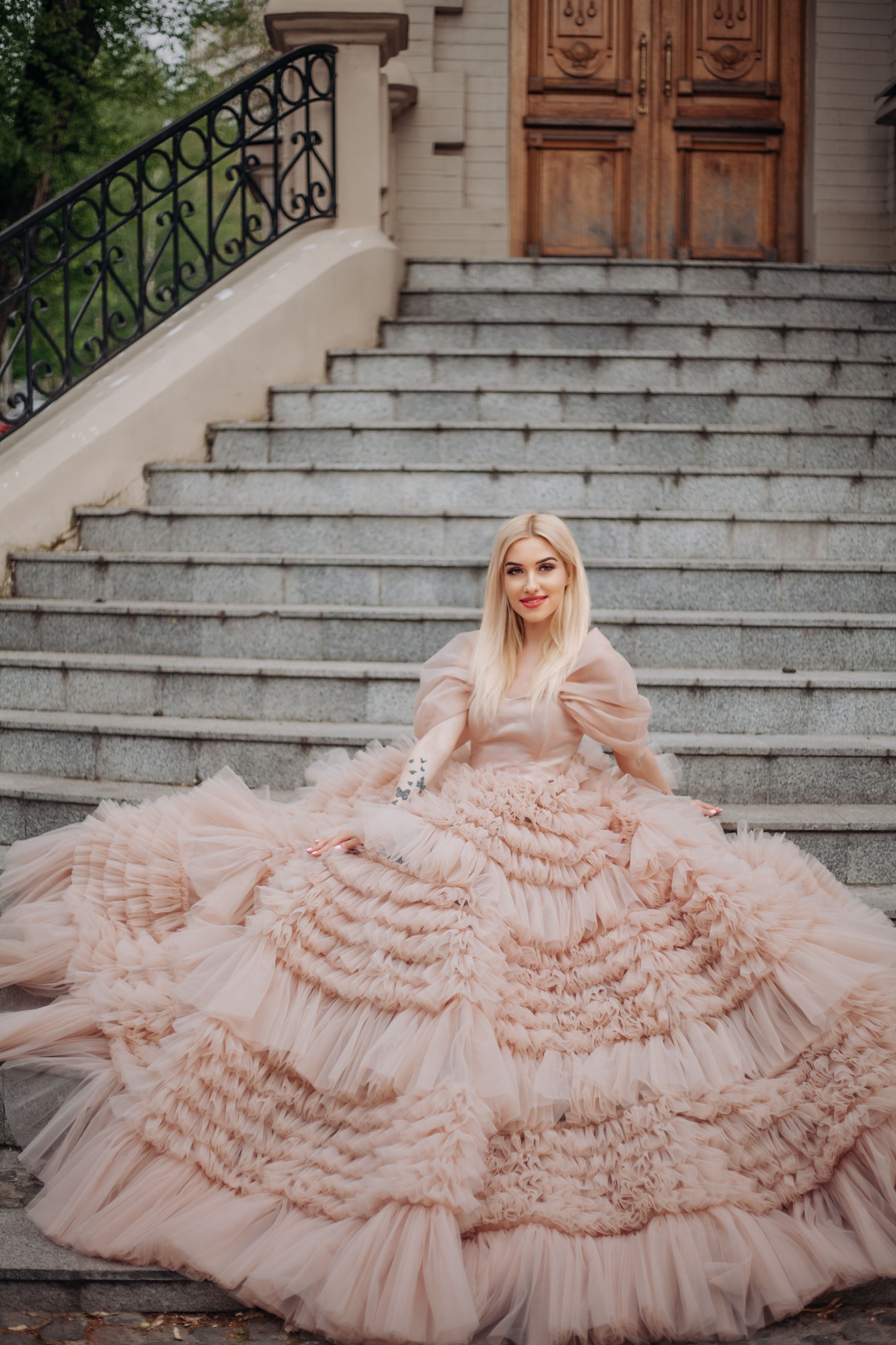Elegant Woman in Luxurious Ball Gown on Stairs · Free Stock Photo
