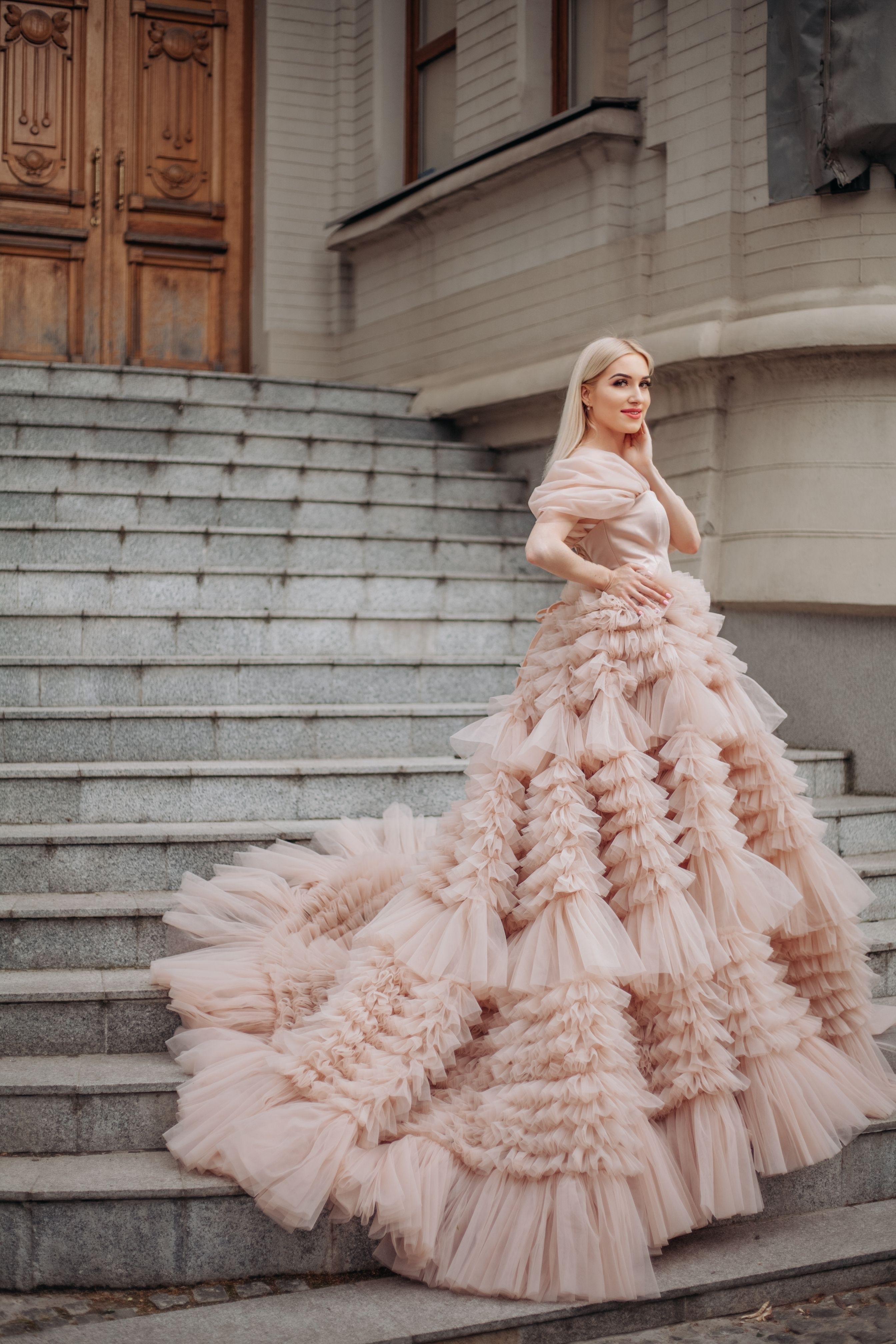 Elegant Woman in Dramatic Gown on Stone Stairs · Free Stock Photo