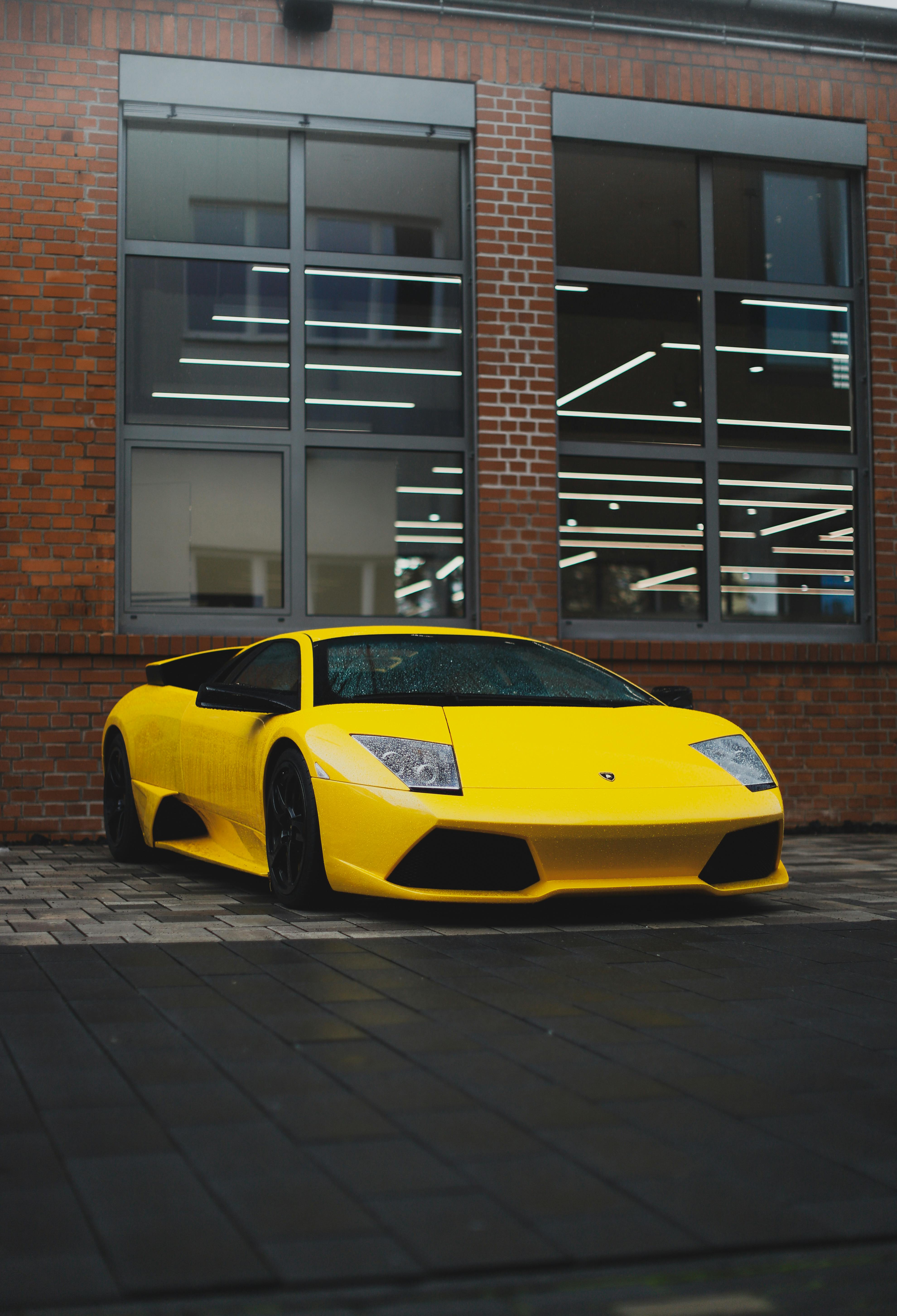 Bright Yellow Sports Car by Modern Building · Free Stock Photo