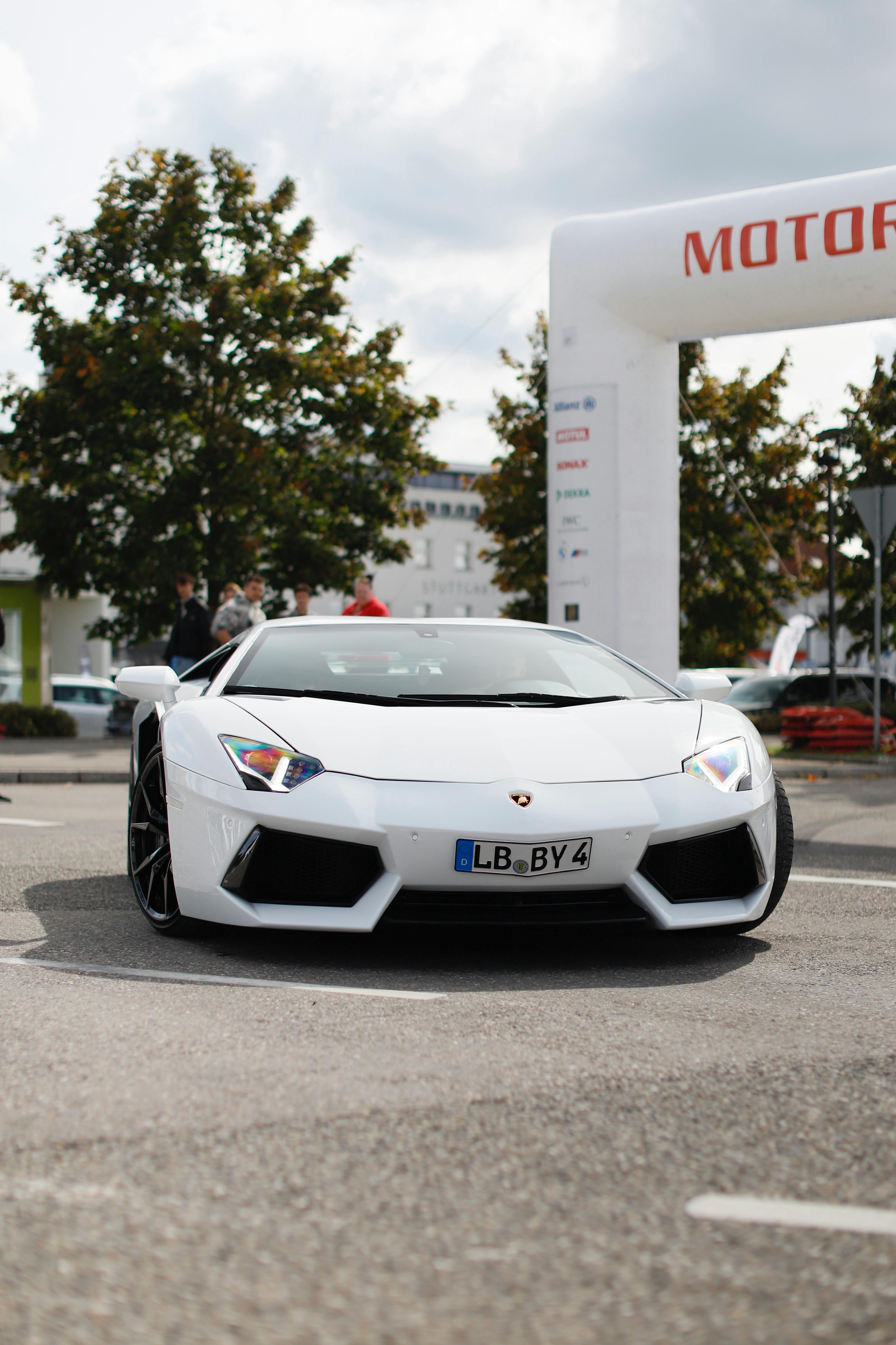 Sleek White Sports Car at Outdoor Auto Show · Free Stock Photo