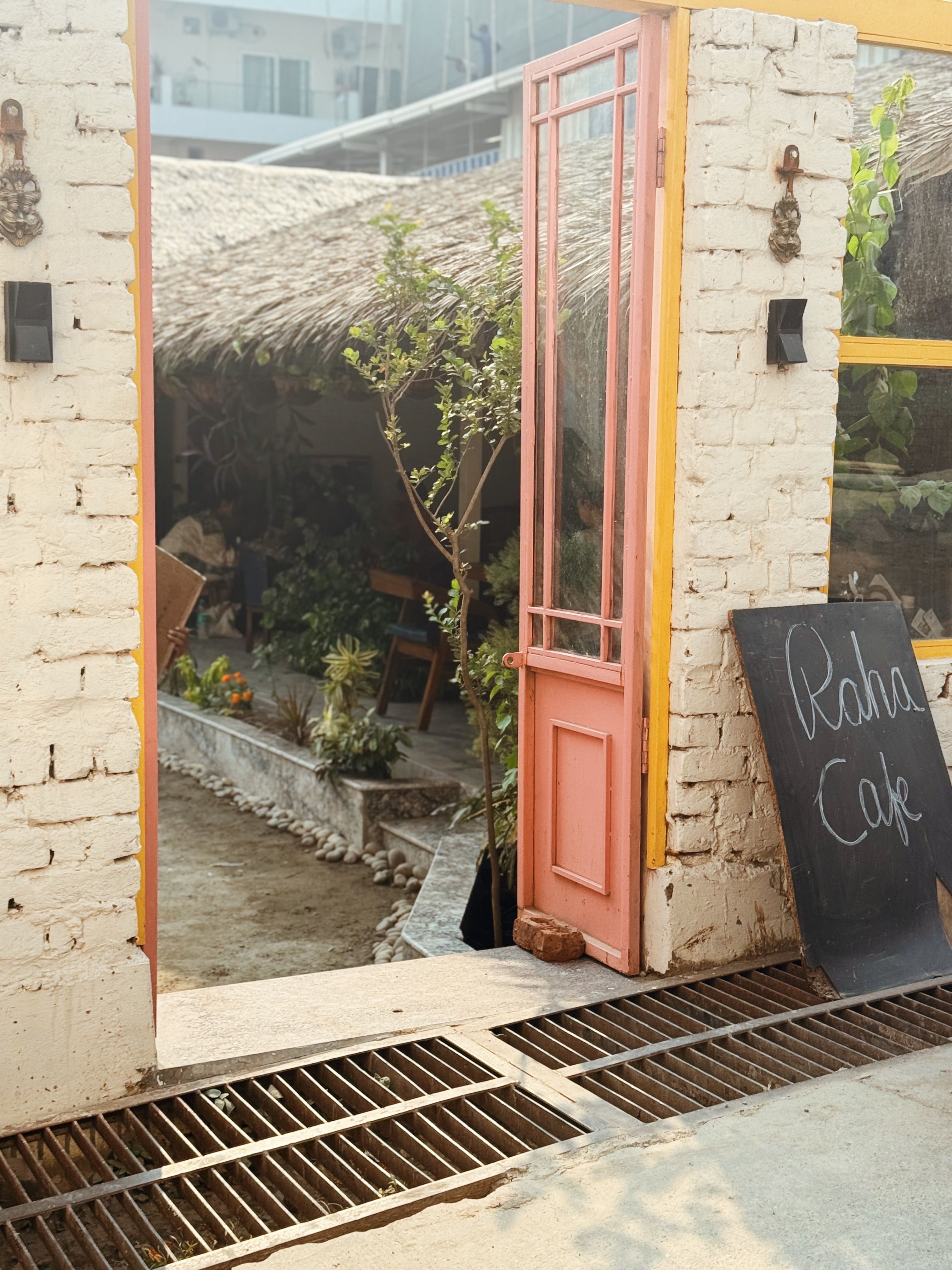 Charming Outdoor Cafe Entrance with Rustic Decor · Free Stock Photo