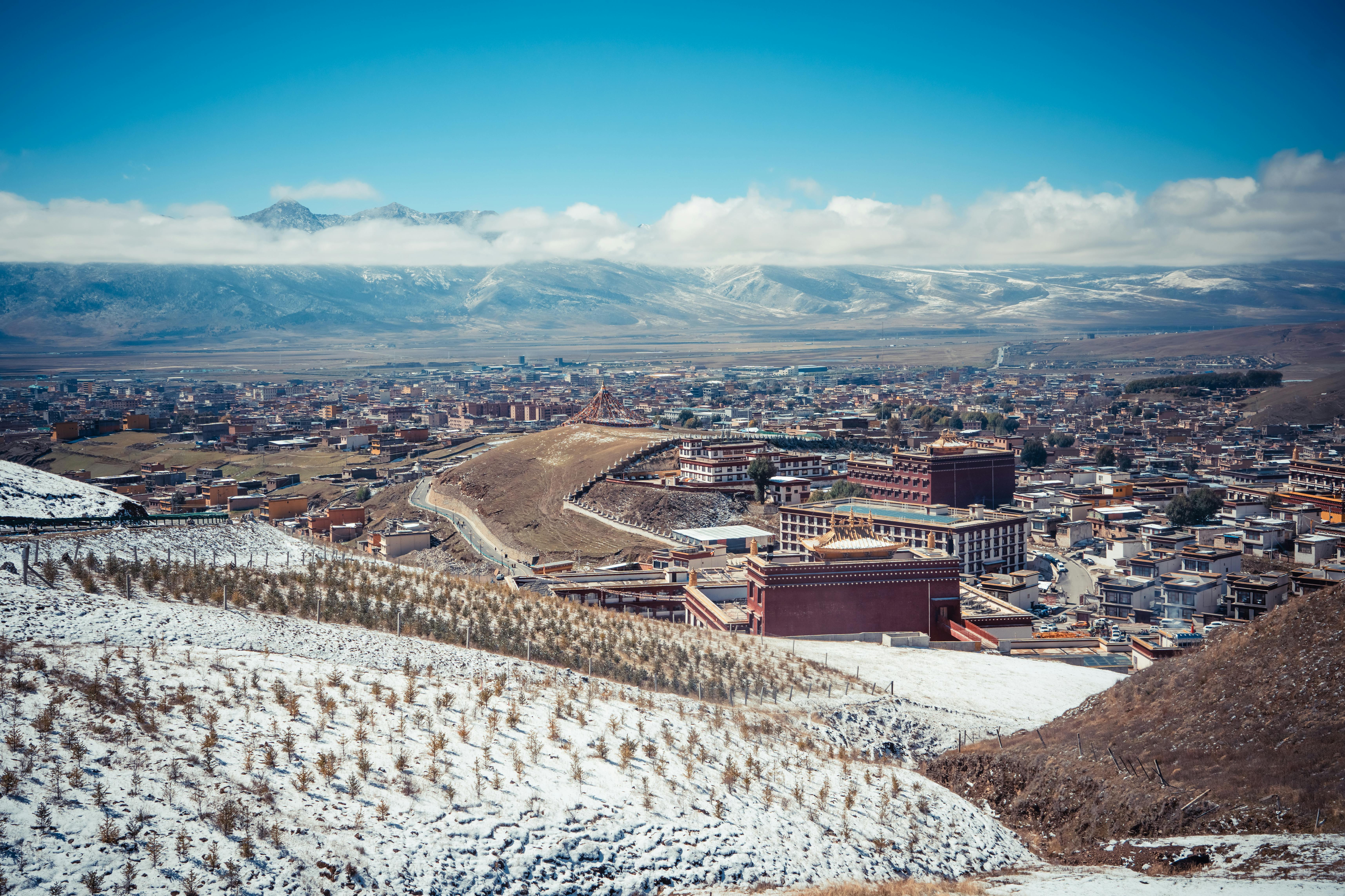 Snowy Landscape Overlooking Tibetan City · Free Stock Photo