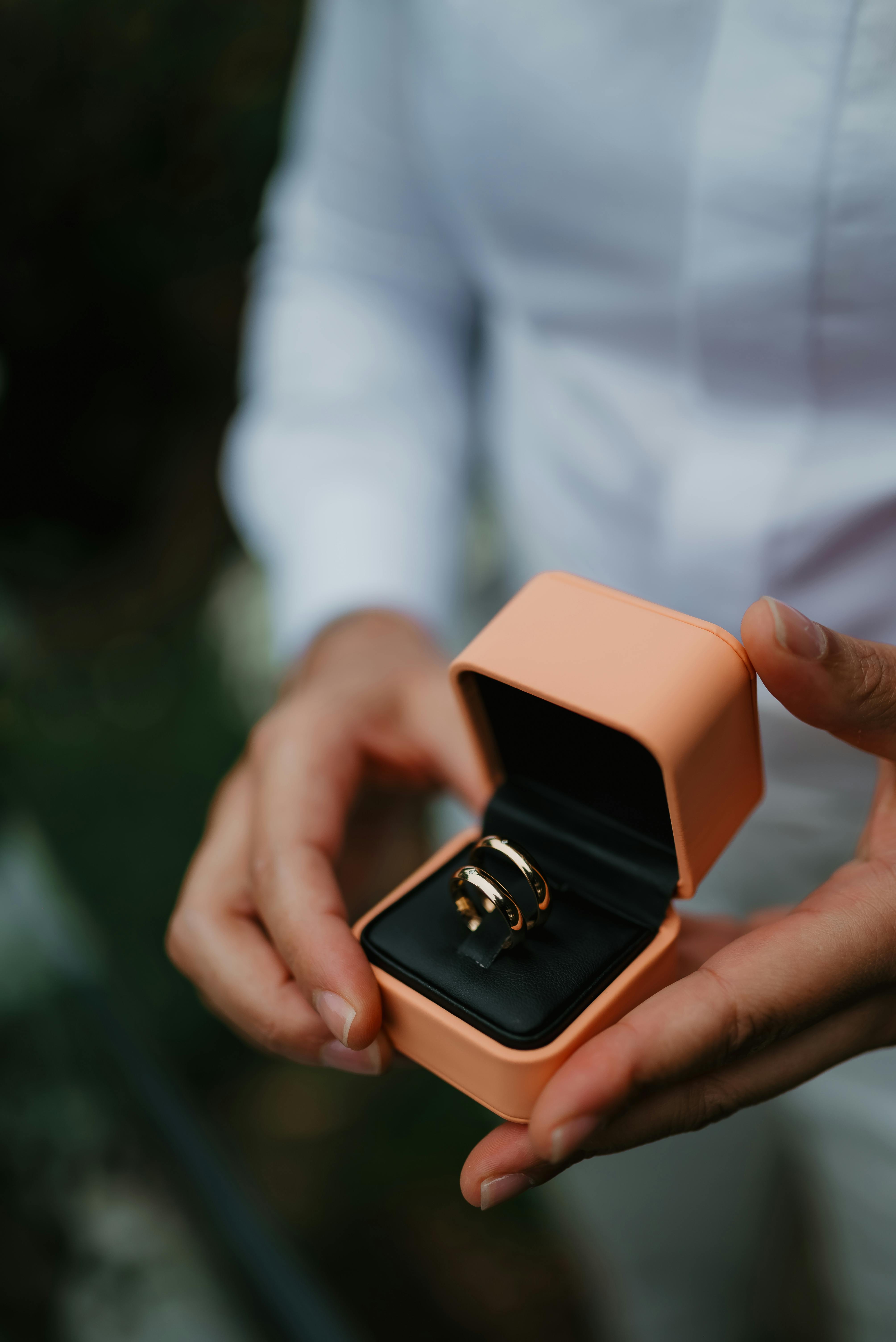 Elegant Ring in Box Held by Person in White Shirt · Free Stock Photo
