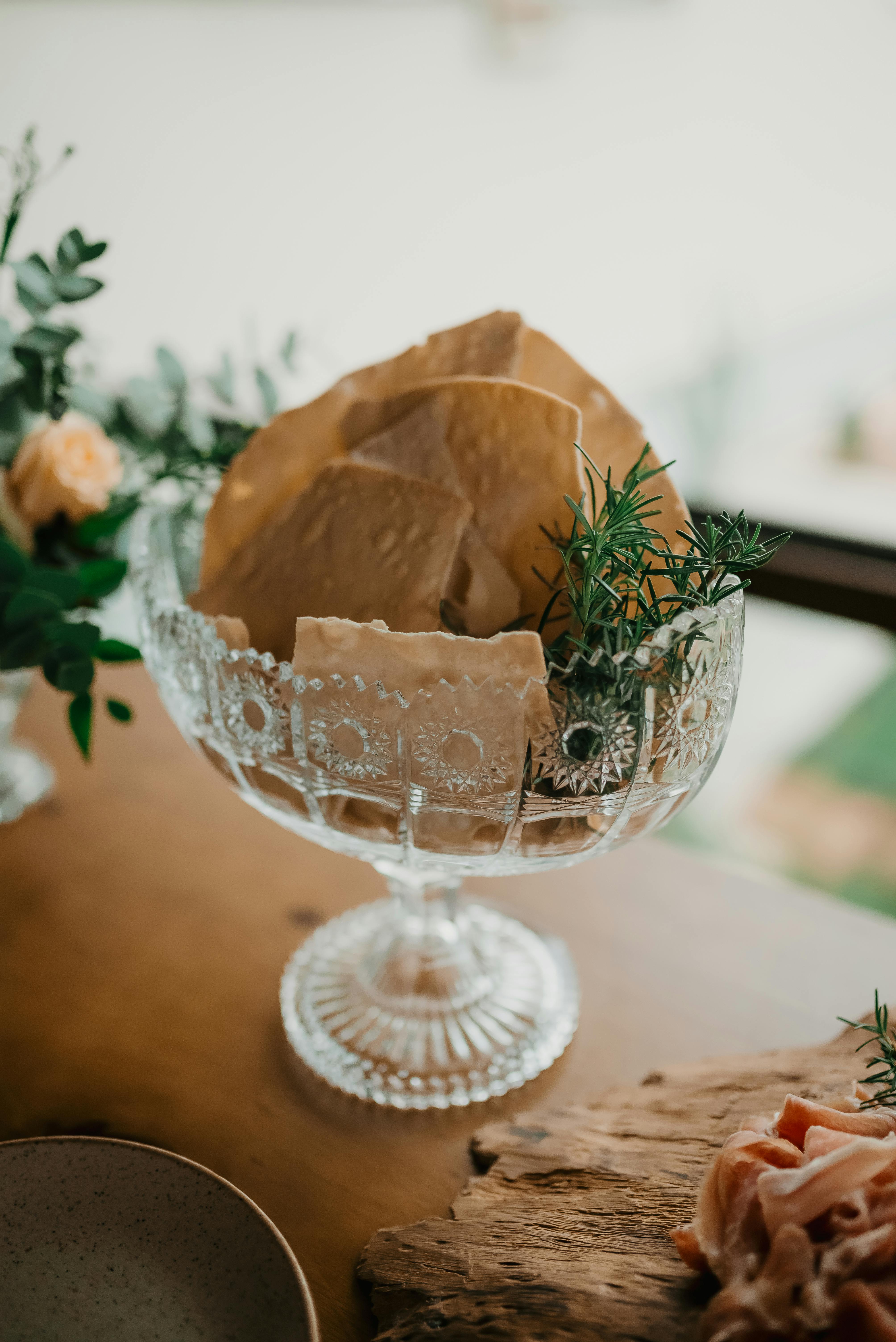 Elegant Glass Bowl with Rustic Crackers Display · Free Stock Photo