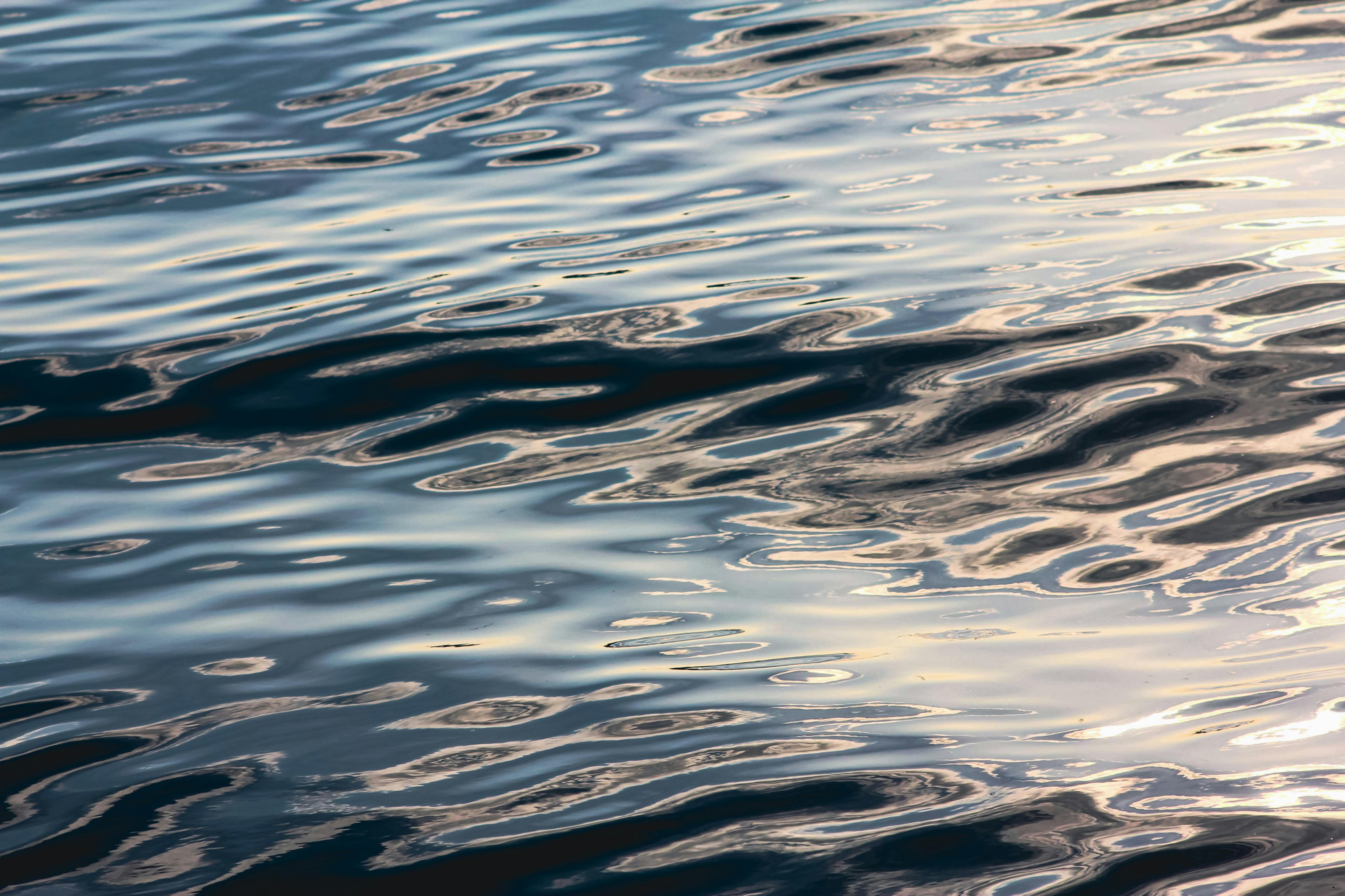 Abstract Rippling Water Surface at Sunset · Free Stock Photo