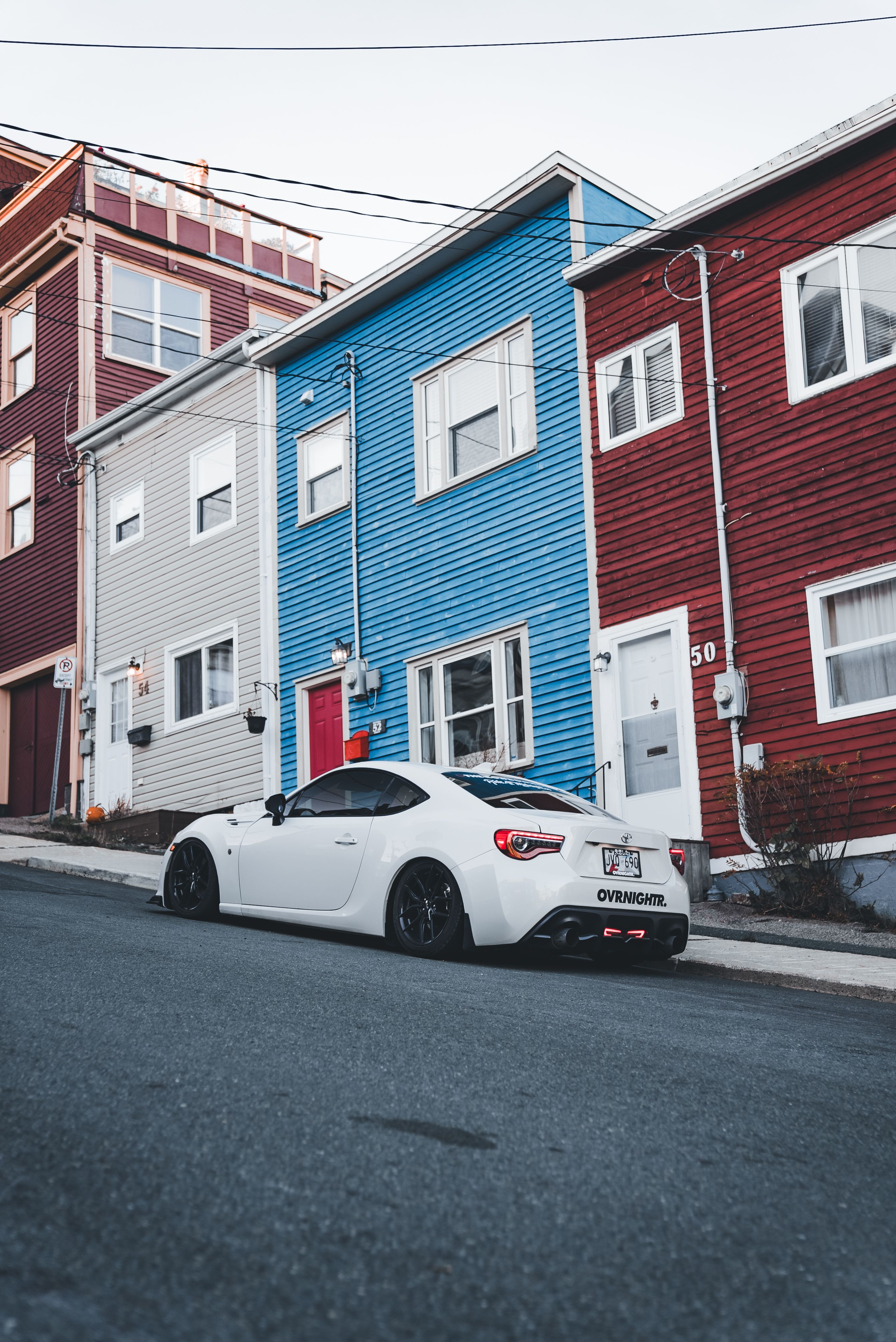White Sports Car Parked on Urban Street · Free Stock Photo