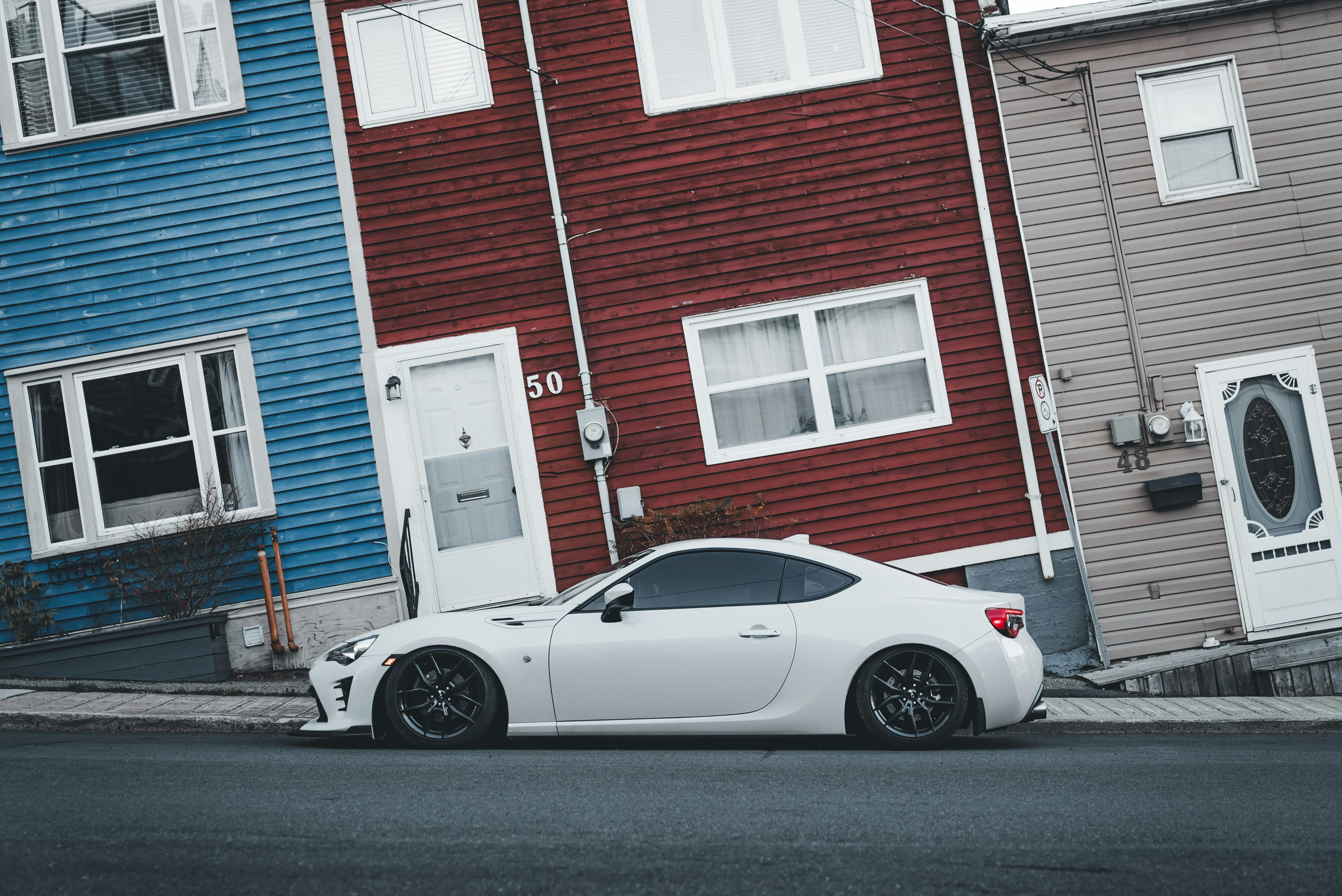 White Car Parked in Front of Colorful Houses on Sloped Street · Free ...