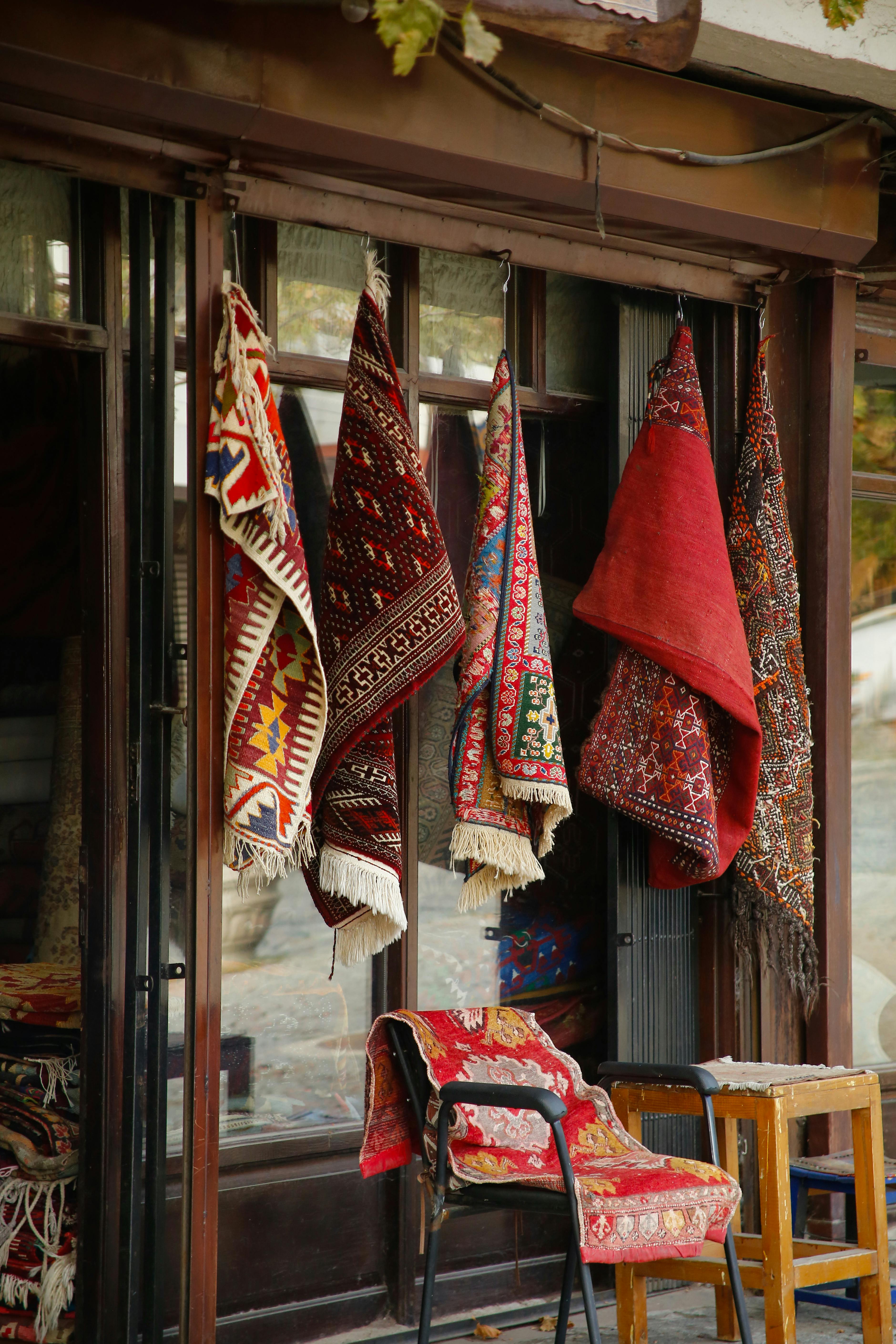 Traditional Turkish Rugs Hanging on Shop Display · Free Stock Photo