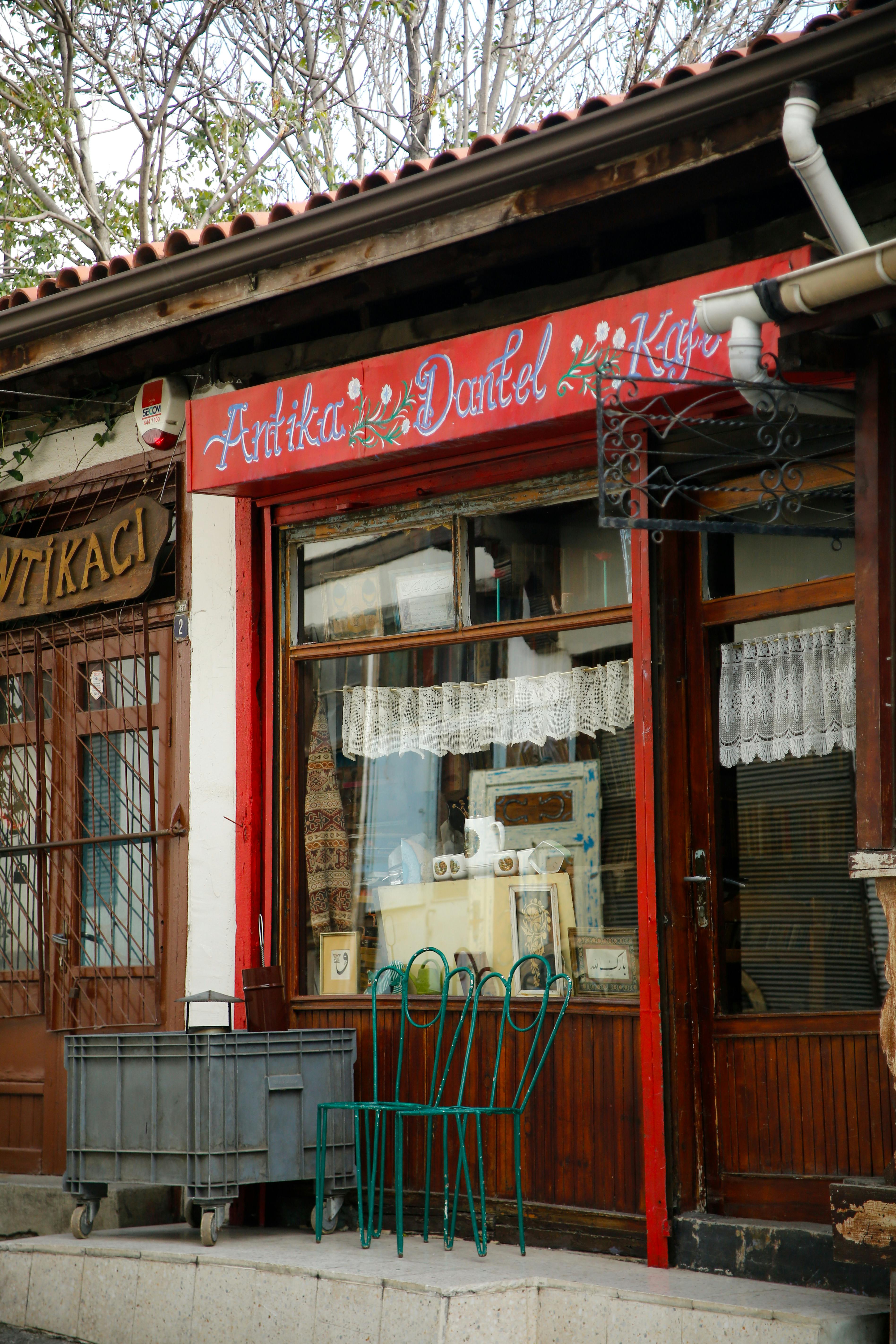 Charming Rustic Café Facade with Red Accents · Free Stock Photo