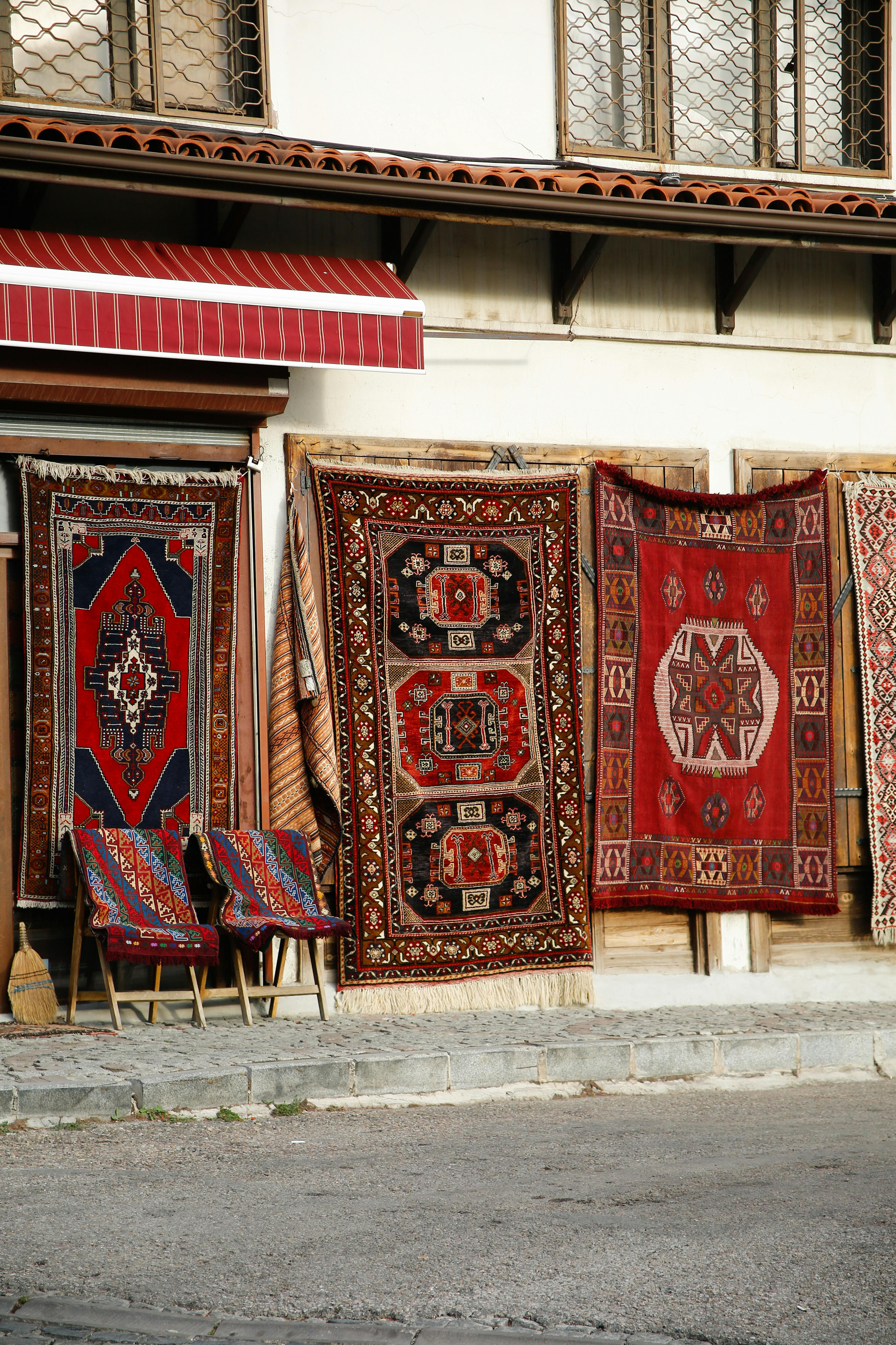 Traditional Oriental Rugs Displayed Outdoors · Free Stock Photo
