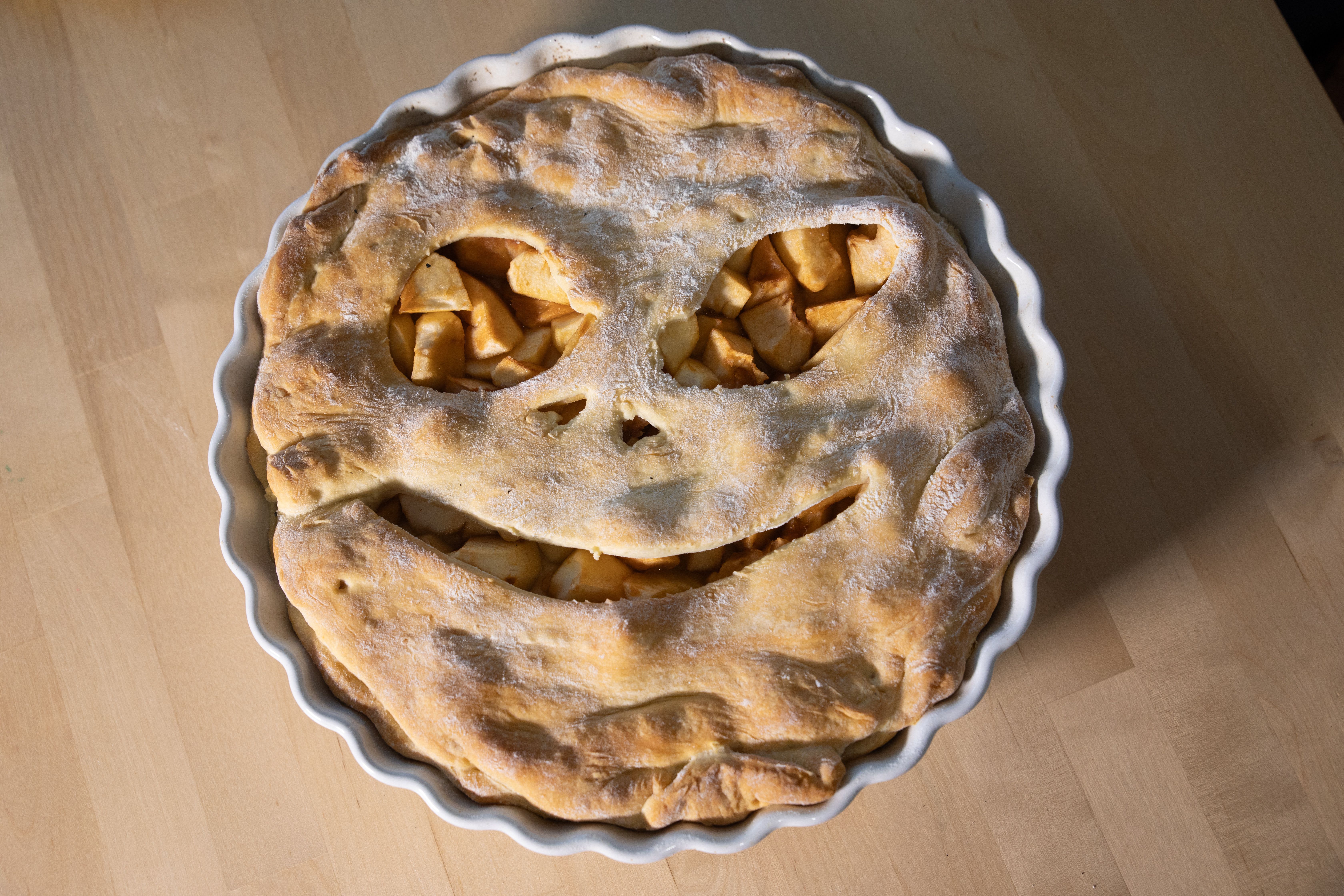 Creative Smiley Face Apple Pie in Rustic Setting · Free Stock Photo