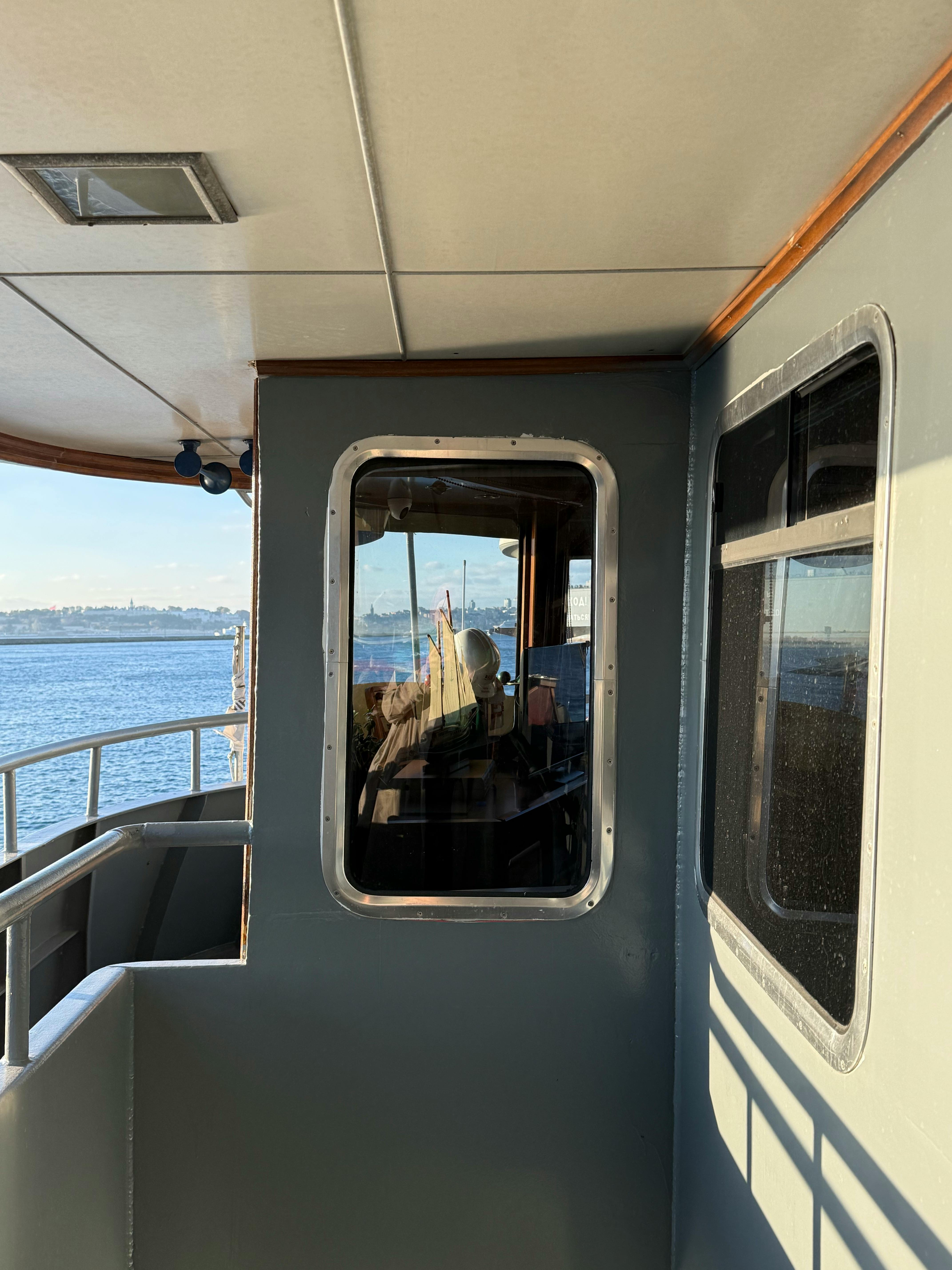 Reflection on Boat Cabin Window with Ocean View · Free Stock Photo