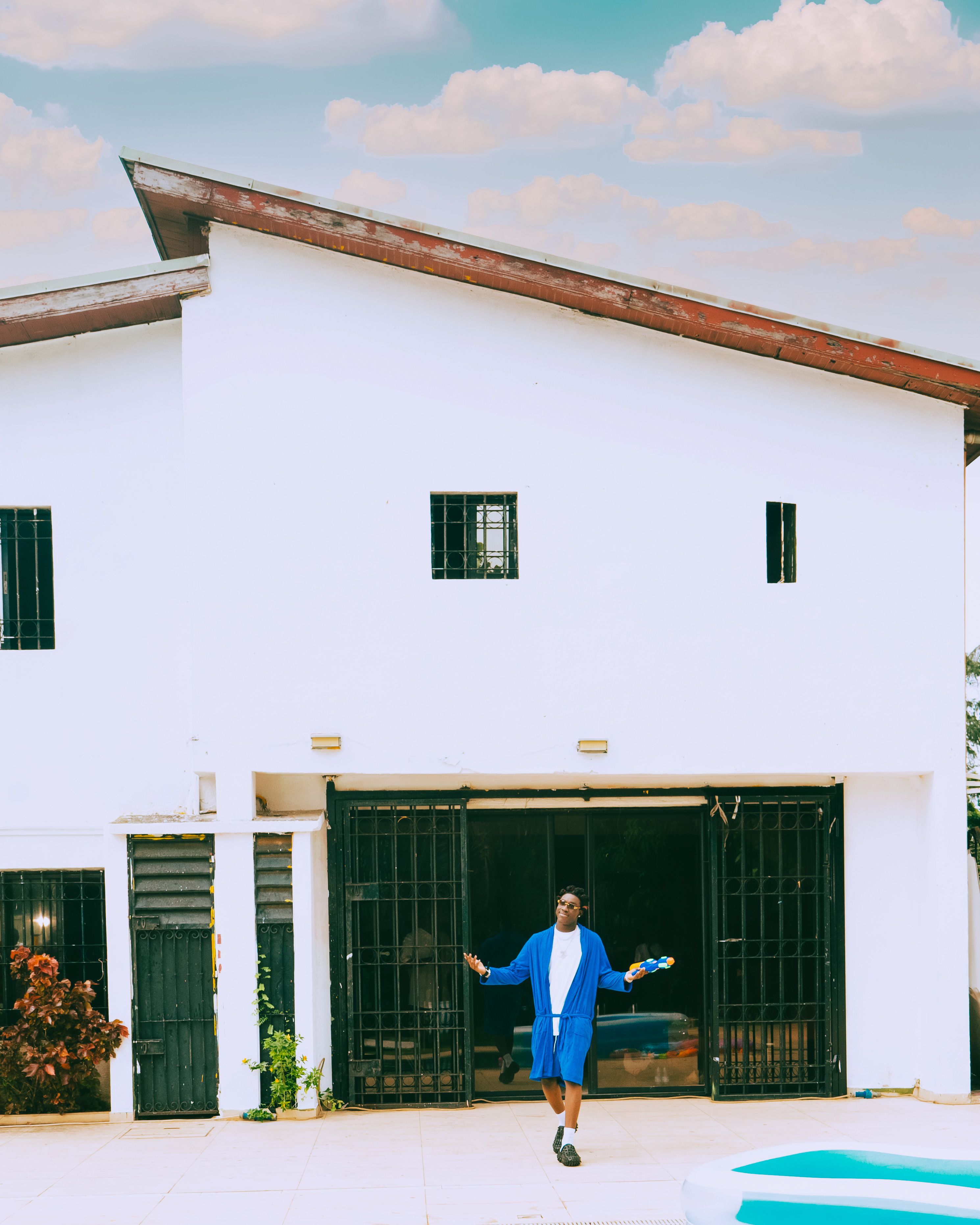 Man Enjoying a Relaxed Day Outside Modern House · Free Stock Photo