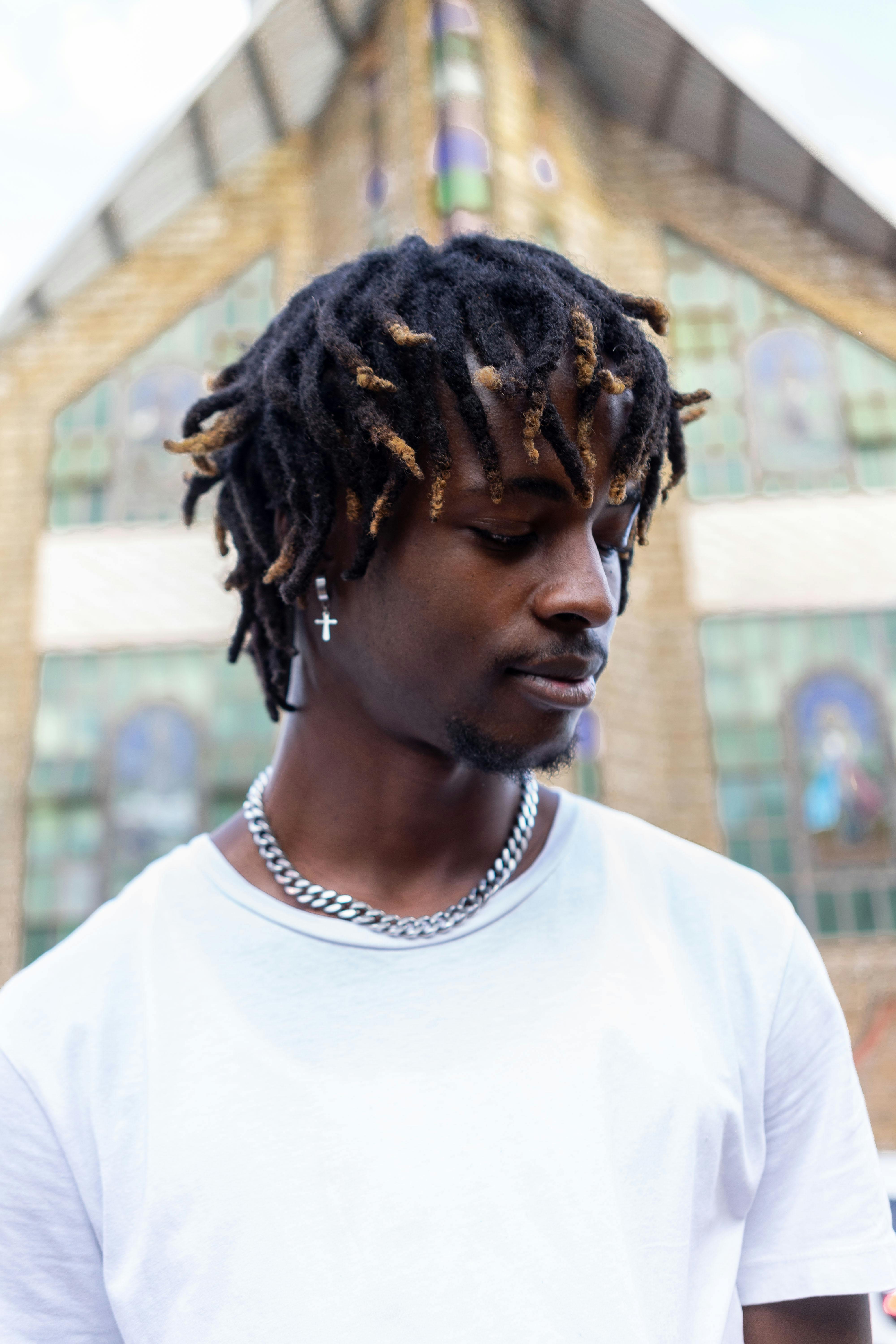 Young Man with Dreadlocks Outside Kenyan Church · Free Stock Photo