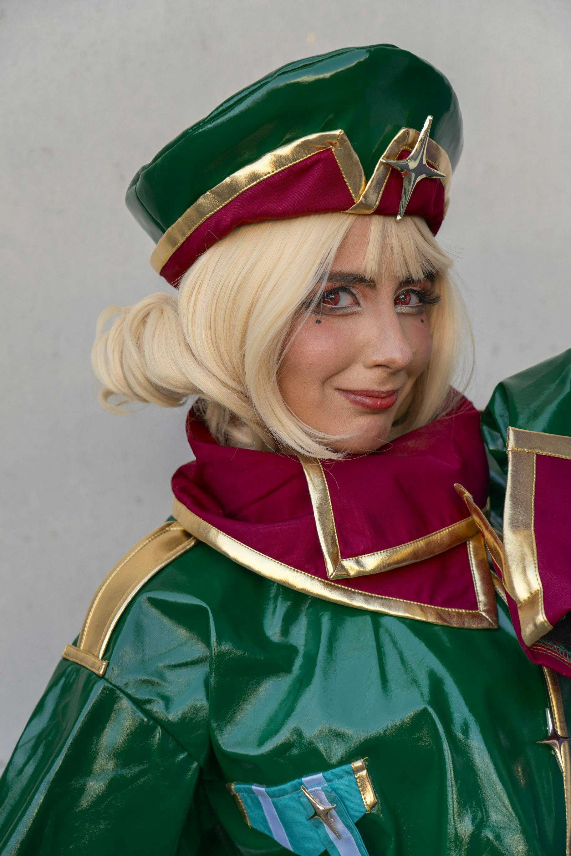 Cosplayer in Green and Red Costume at Convention · Free Stock Photo