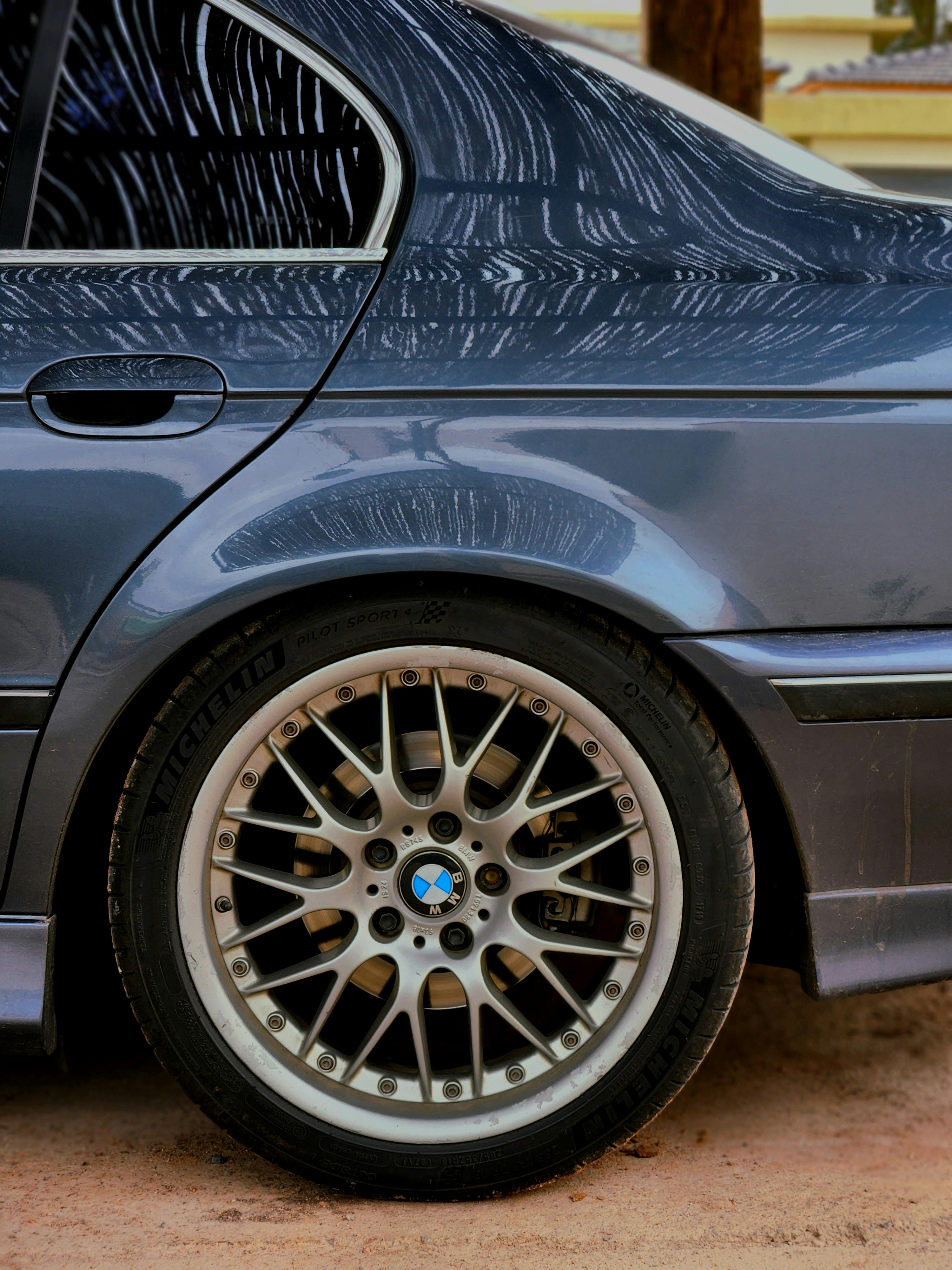 Close-up of Car Wheel with Alloy Rim and Reflections · Free Stock Photo