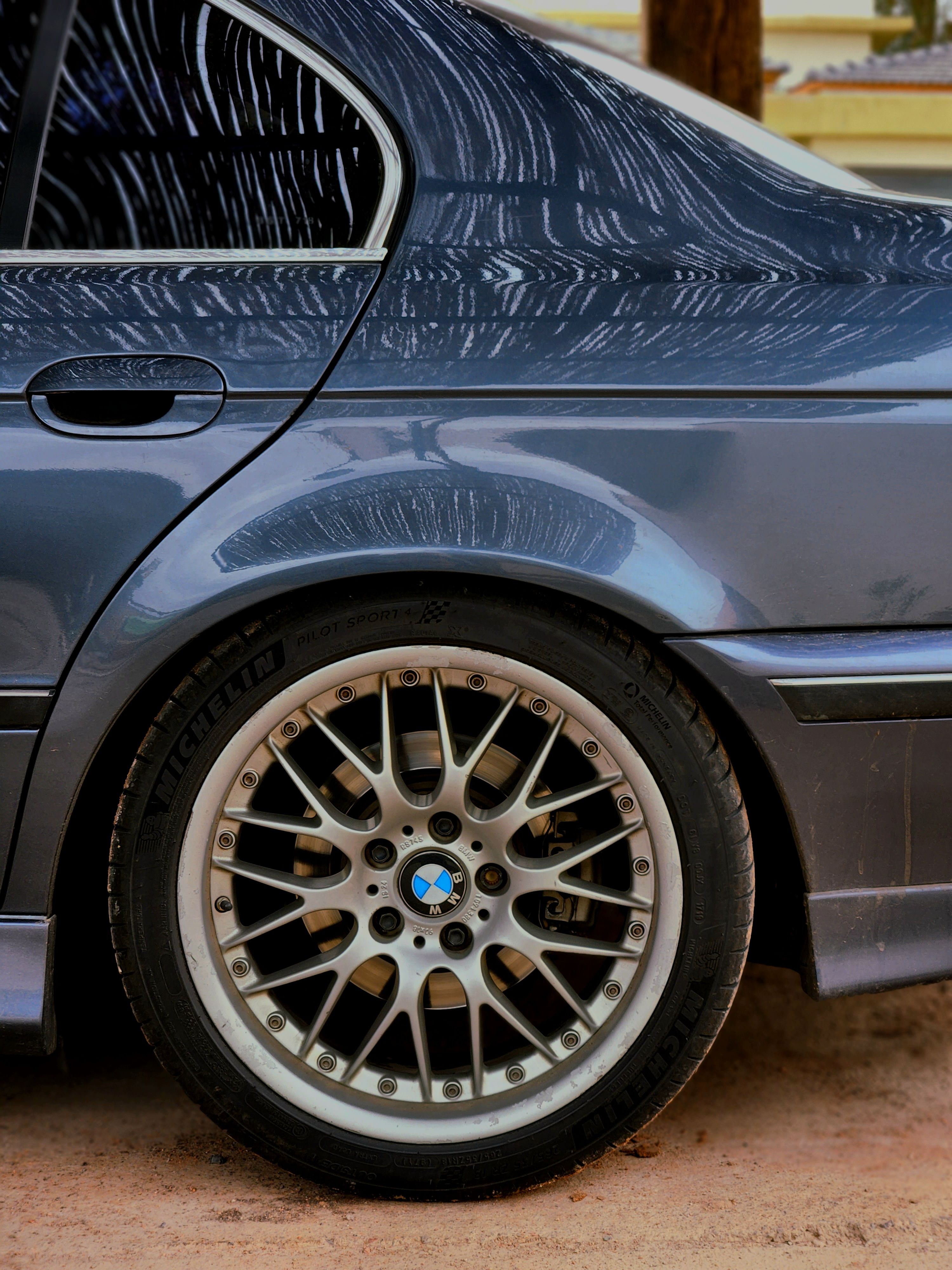 Close-up of Car Wheel with Alloy Rim and Reflections · Free Stock Photo