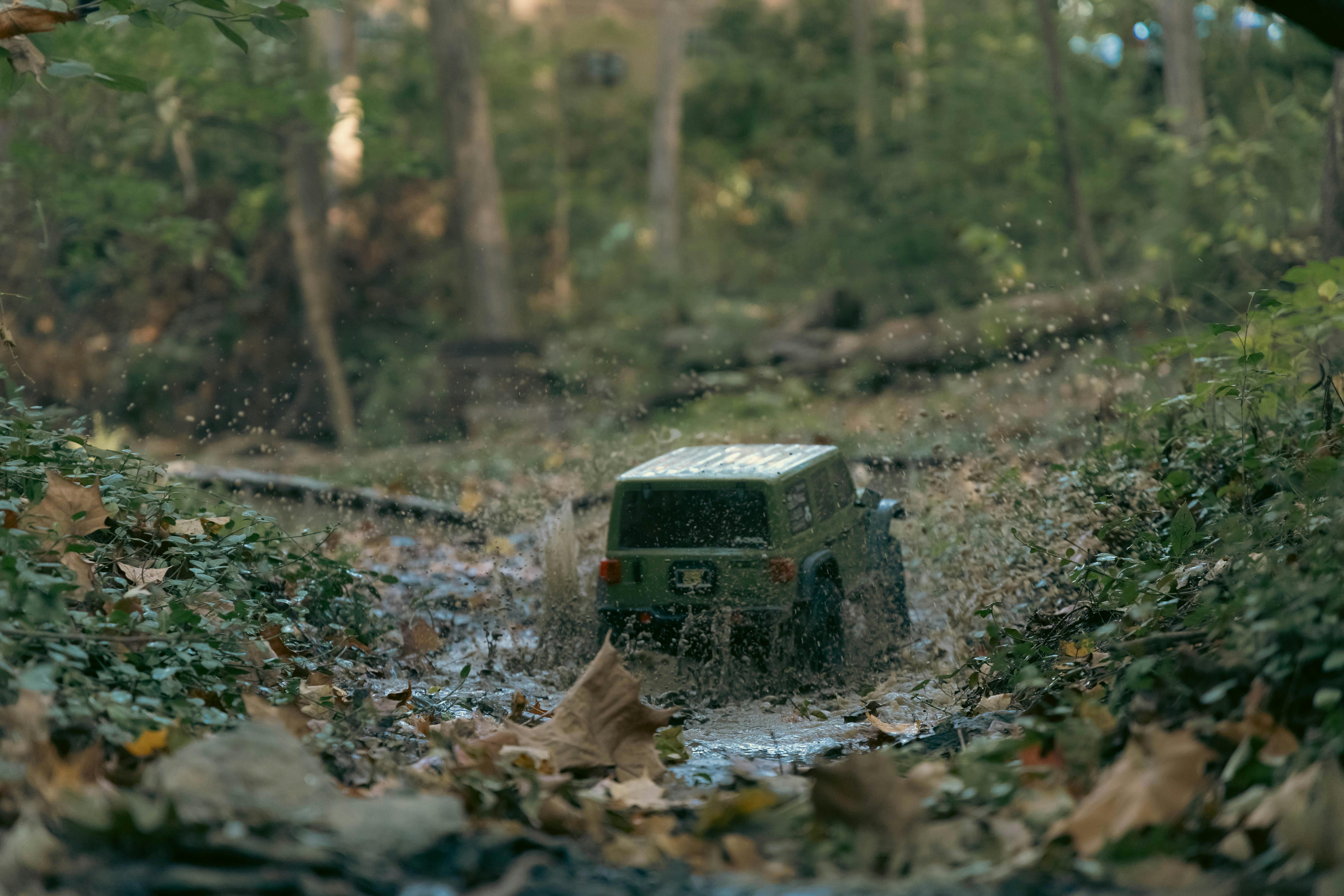 Miniature SUV Off-Roading in Lush Forest Setting · Free Stock Photo