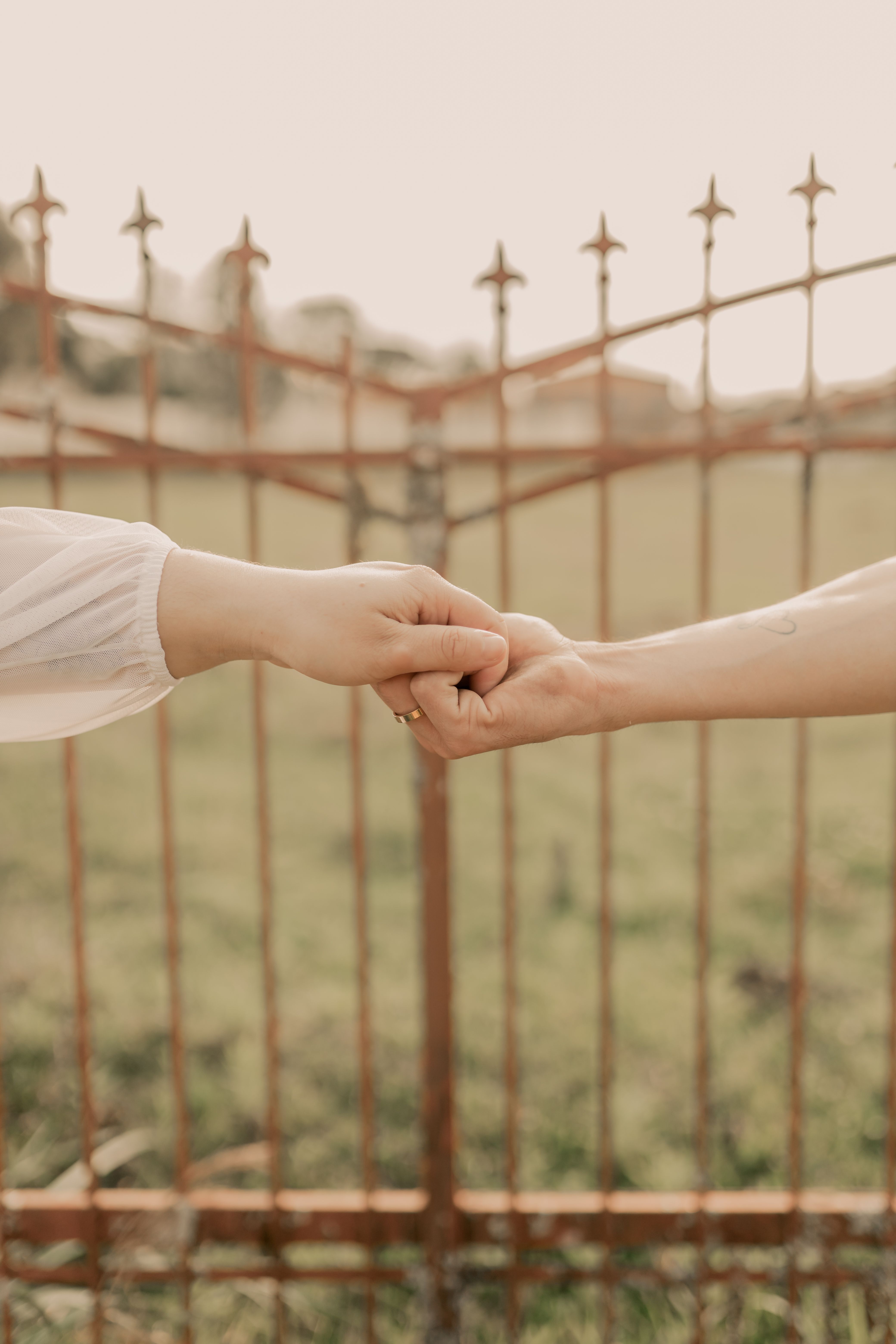 Romantic Connection: Holding Hands Outdoors · Free Stock Photo