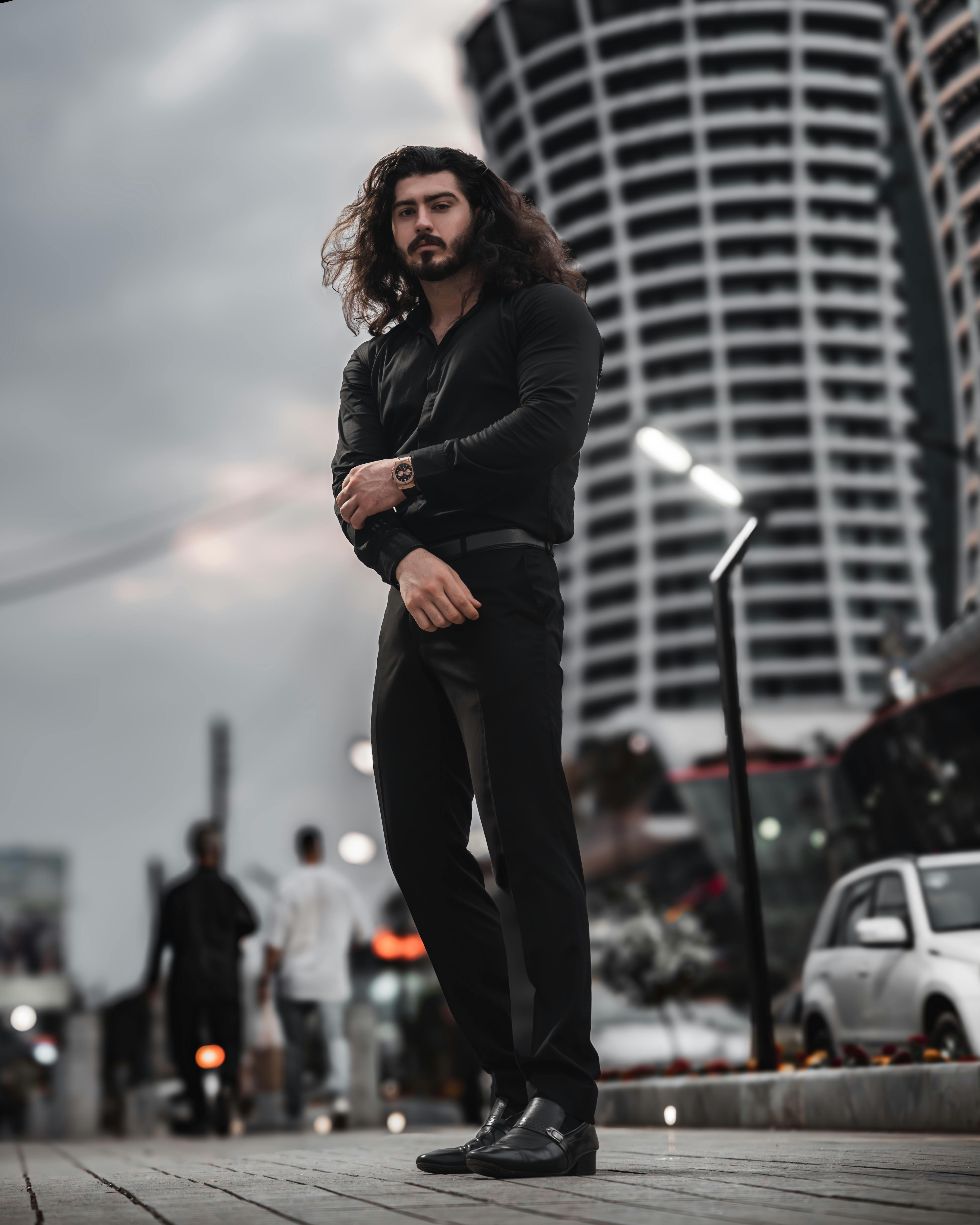 Man Standing with Urban Skyline Background · Free Stock Photo