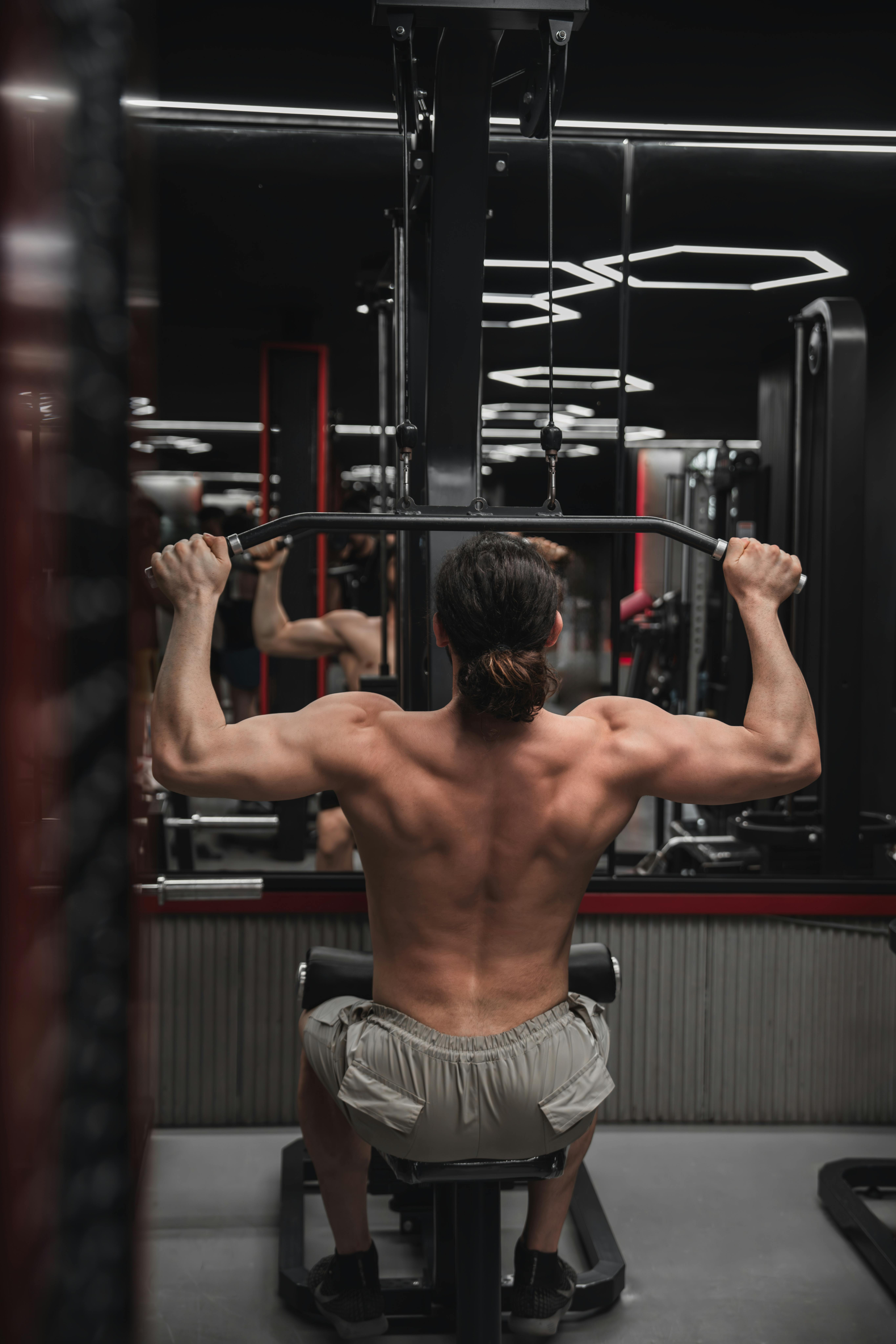 Man In Black Crew-neck Shirt Doing Pull-ups · Free Stock Photo