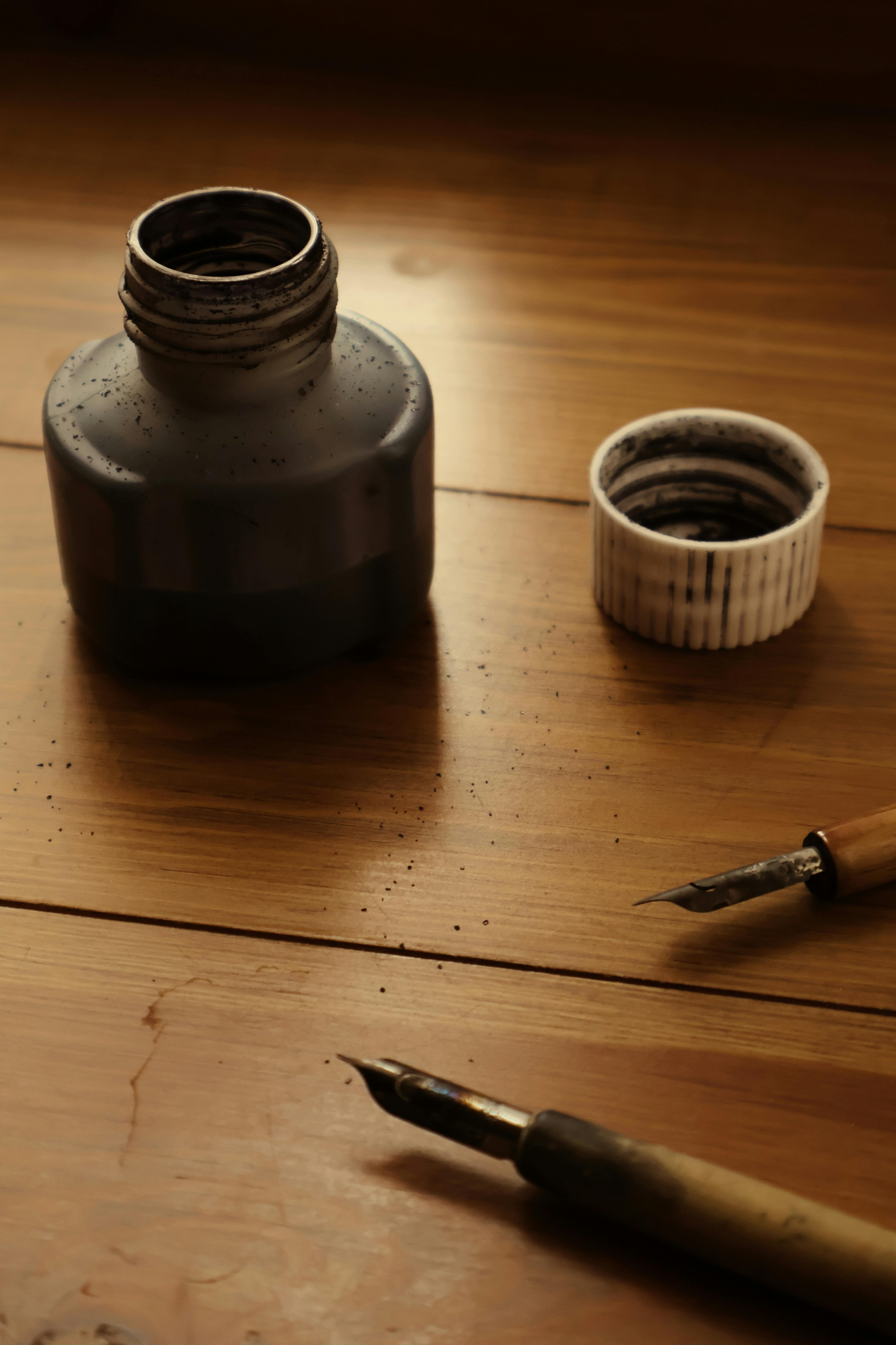 Person dipping Quill Pen in an Ink · Free Stock Photo