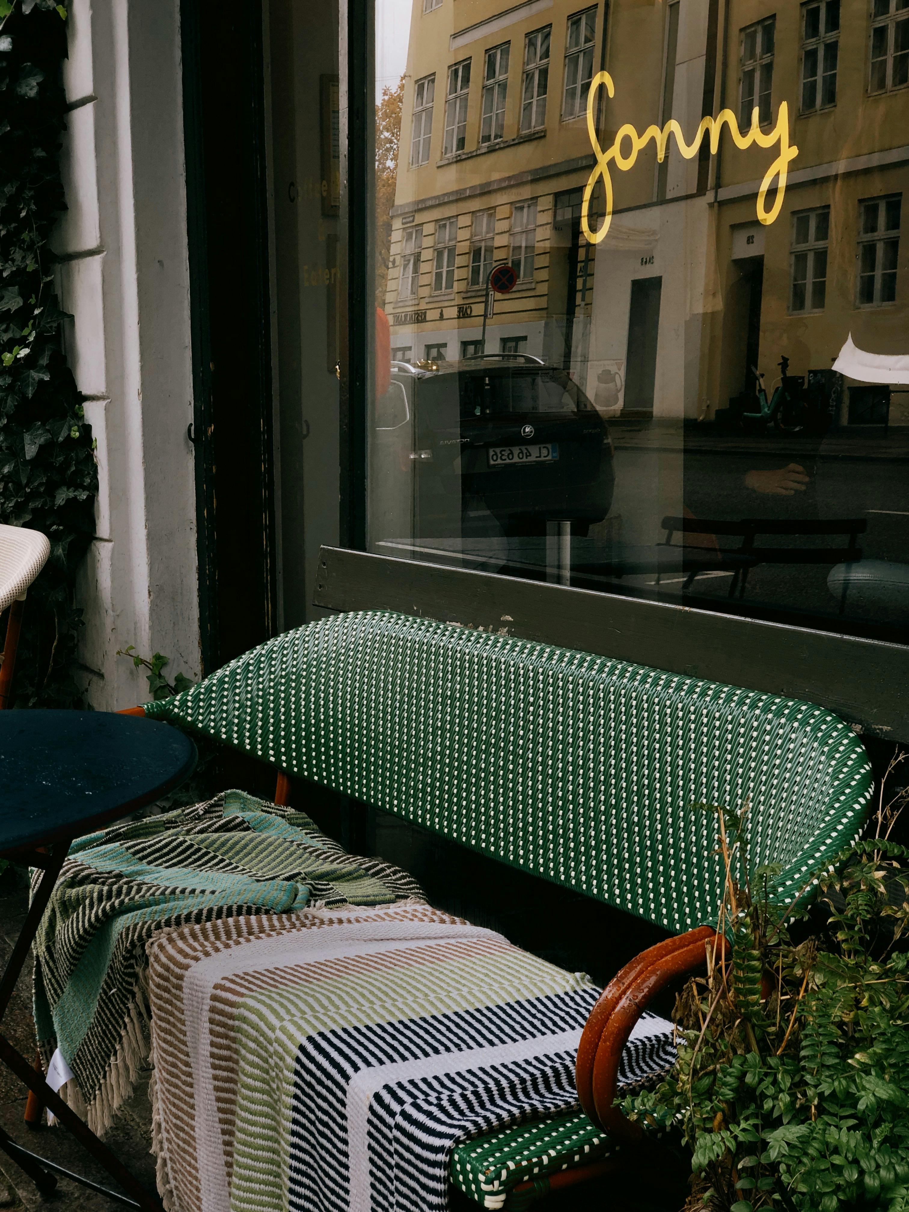 Cozy Outdoor Café Seating with Green Bench · Free Stock Photo