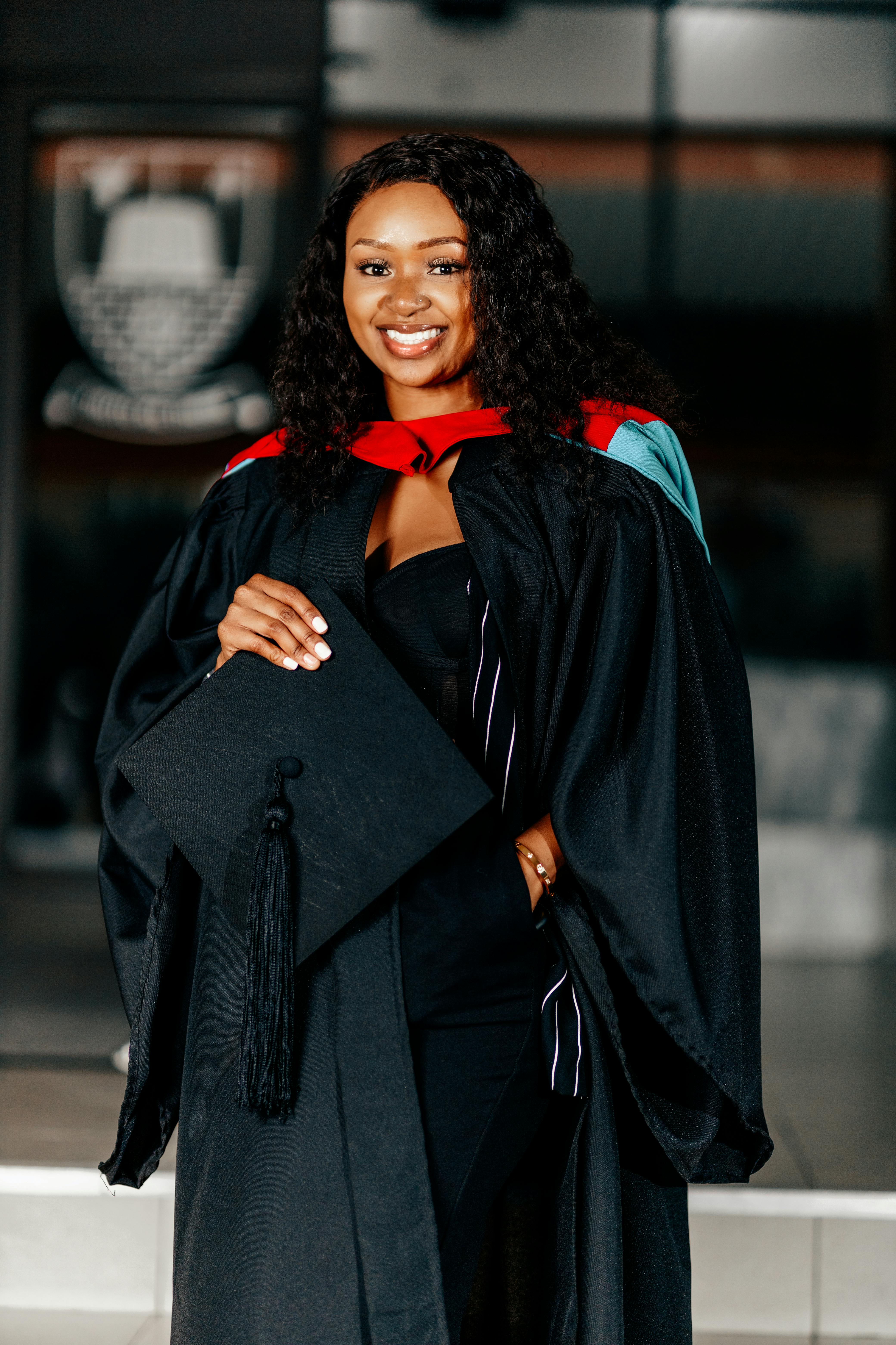University Graduate Celebrating in Cap and Gown · Free Stock Photo
