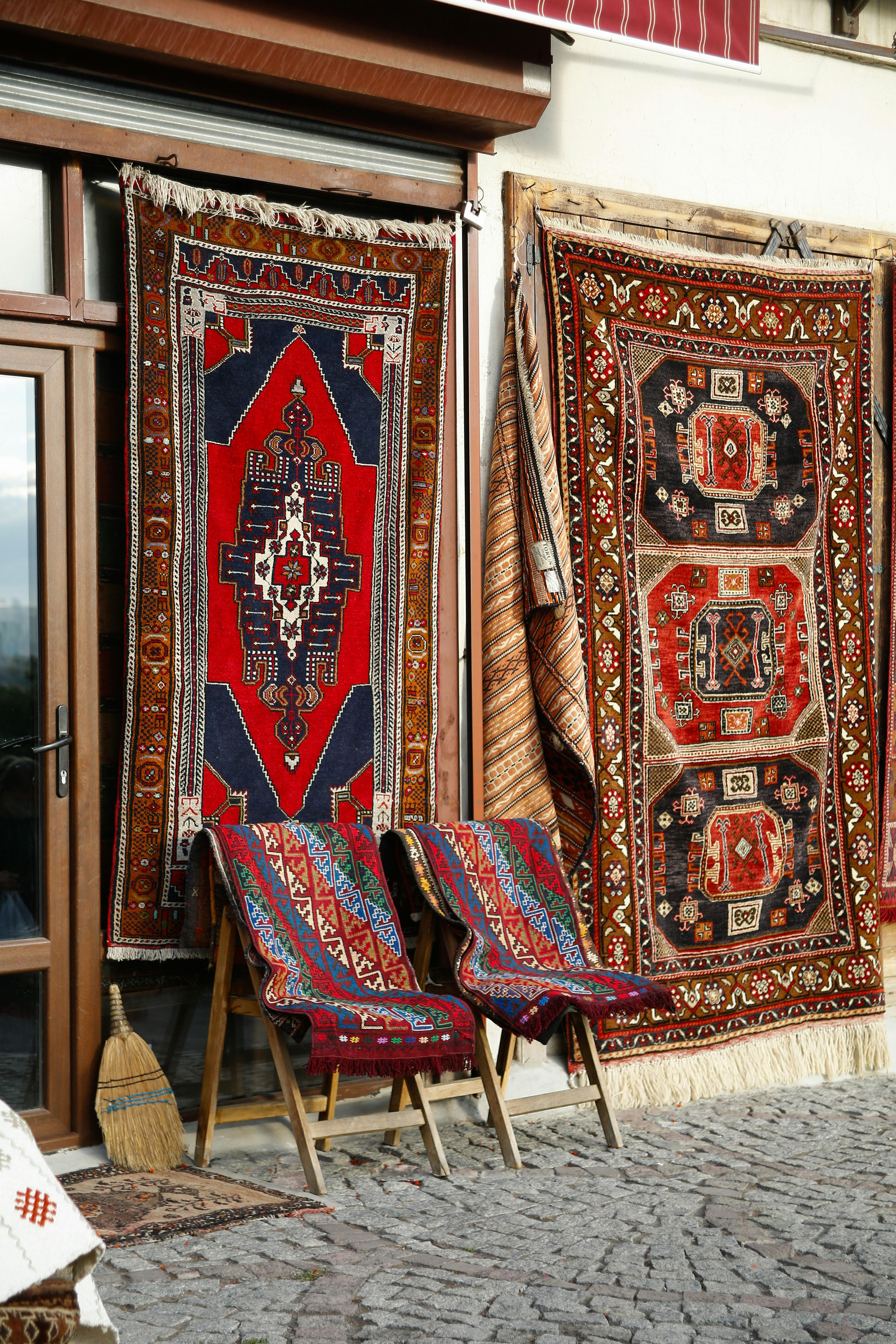 Traditional Oriental Rugs Displayed Outdoors · Free Stock Photo