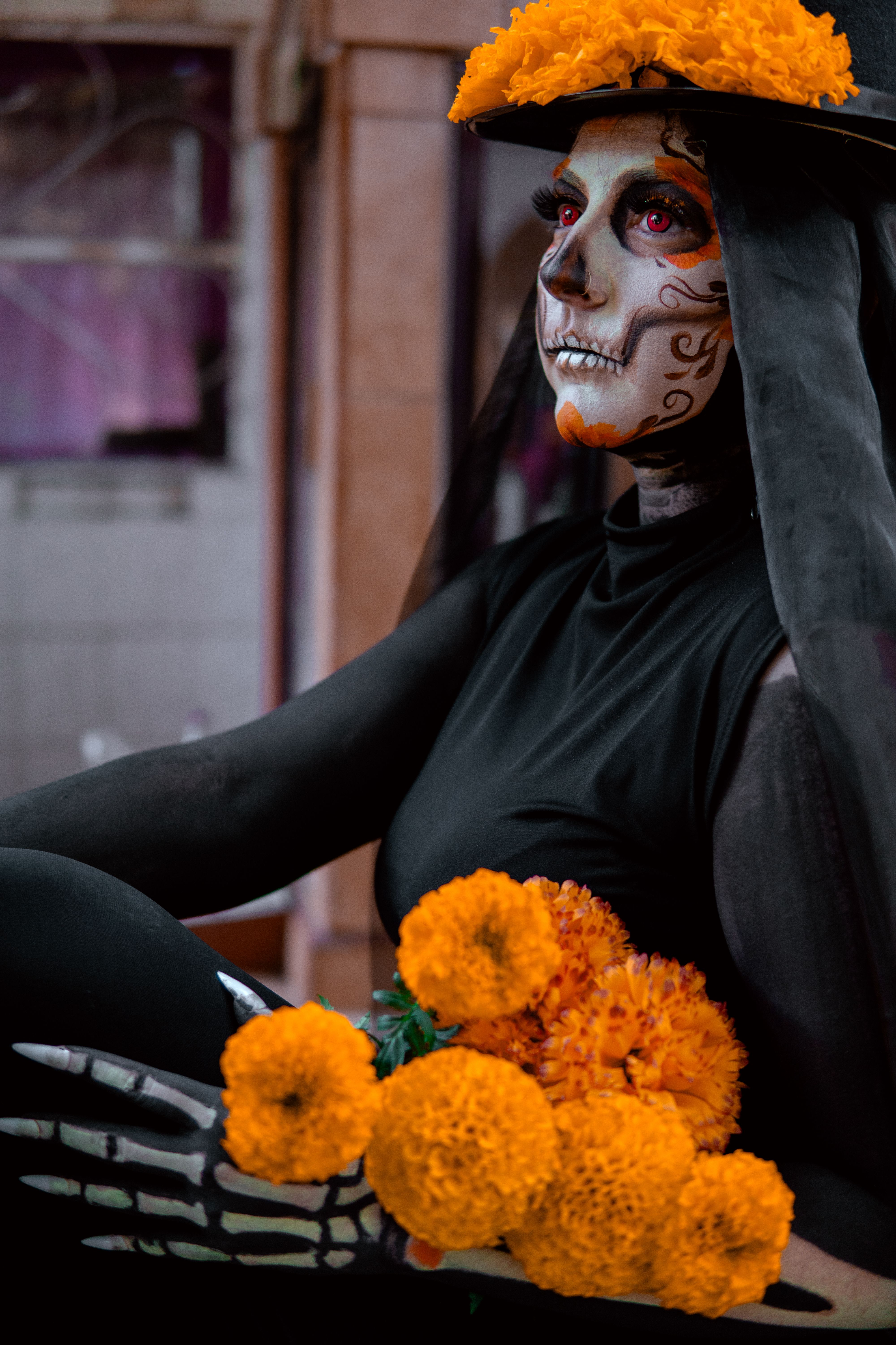 Catrina in Traditional Makeup Holding Marigold Flowers · Free Stock Photo